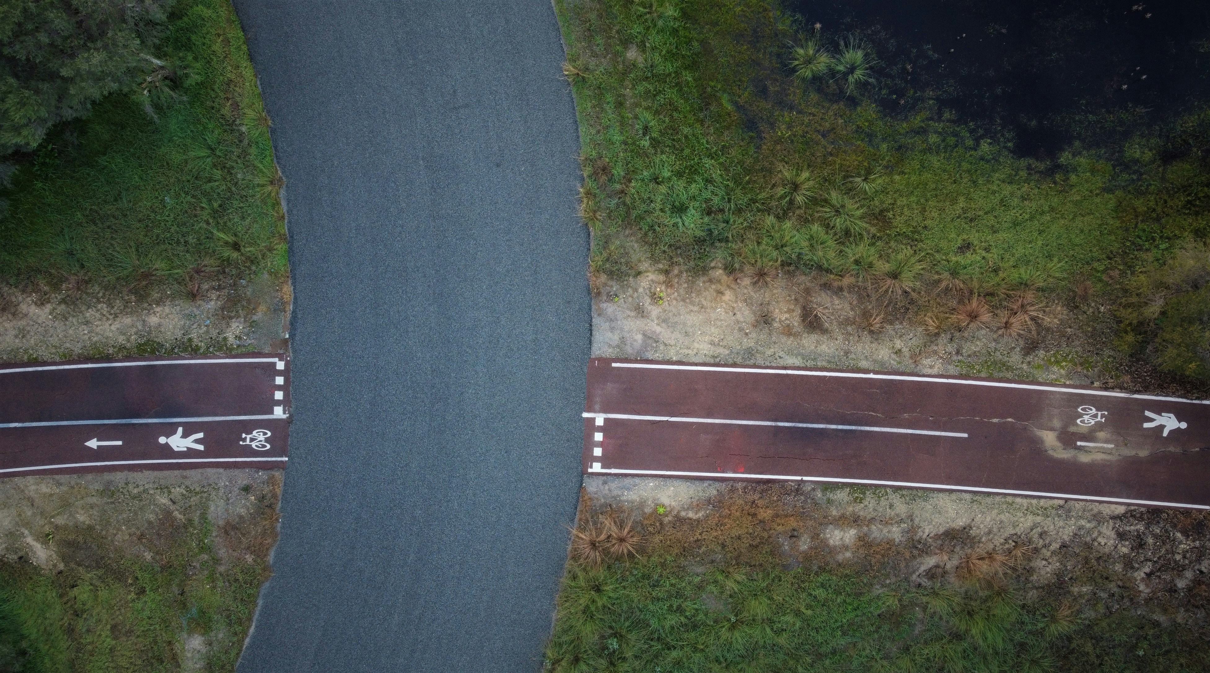 An aerial view of a road with two arrows painted on it photo – Free ...