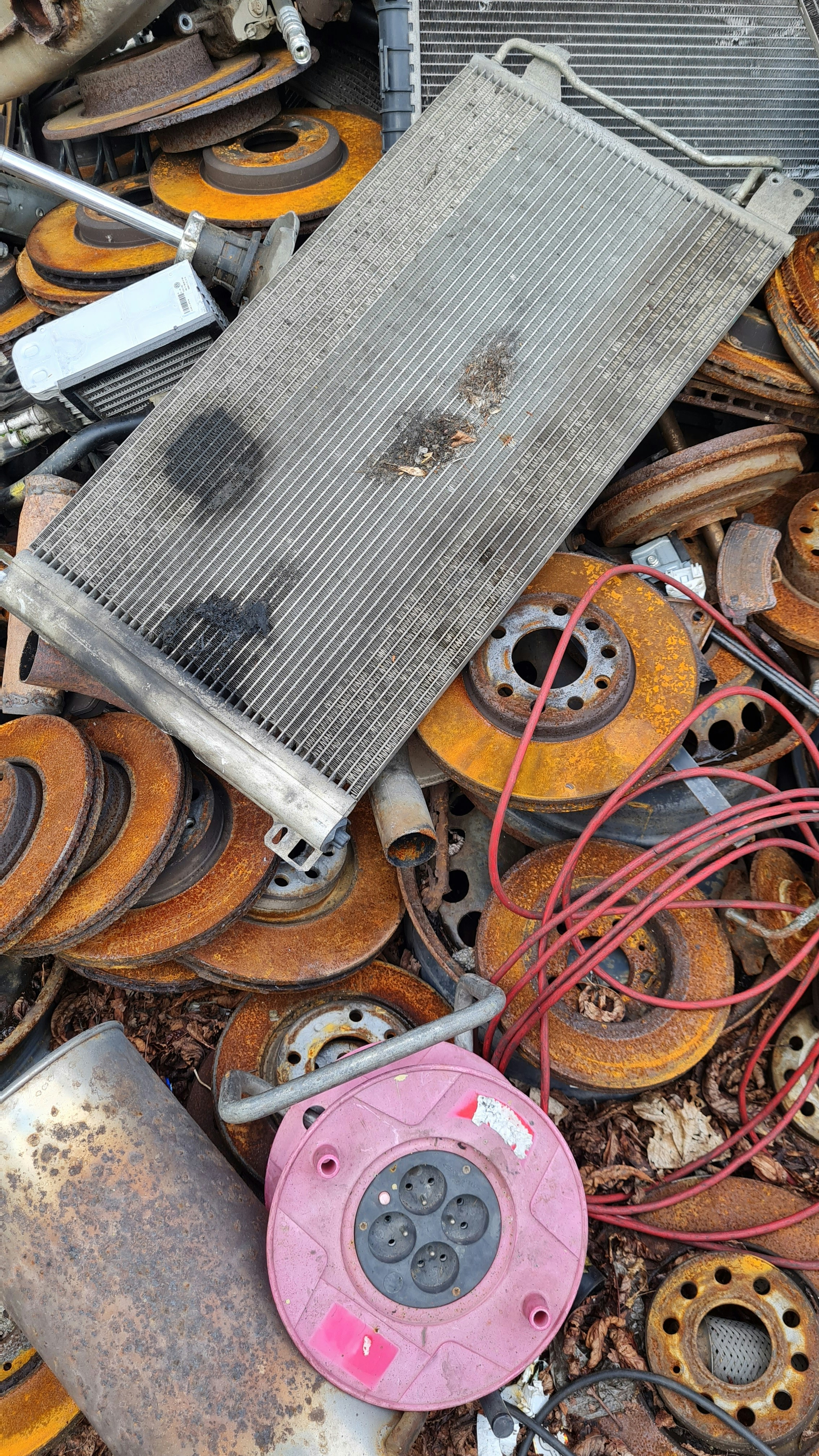 Diagonal Radiator Across a Rusted Junkyard Mosaic