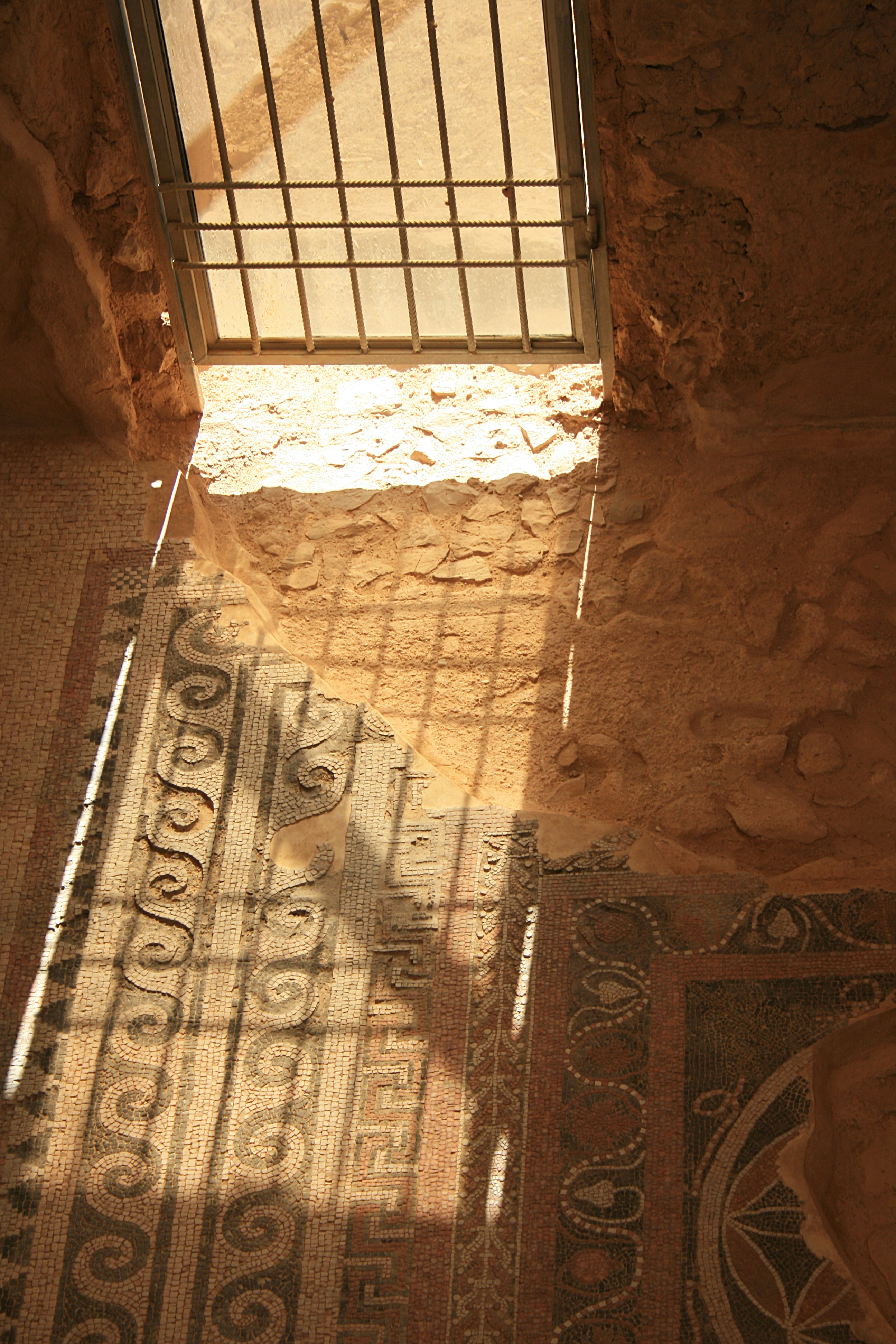 Sunlight Through Iron Grille: Echoes on Timeworn Stone and Mosaic
