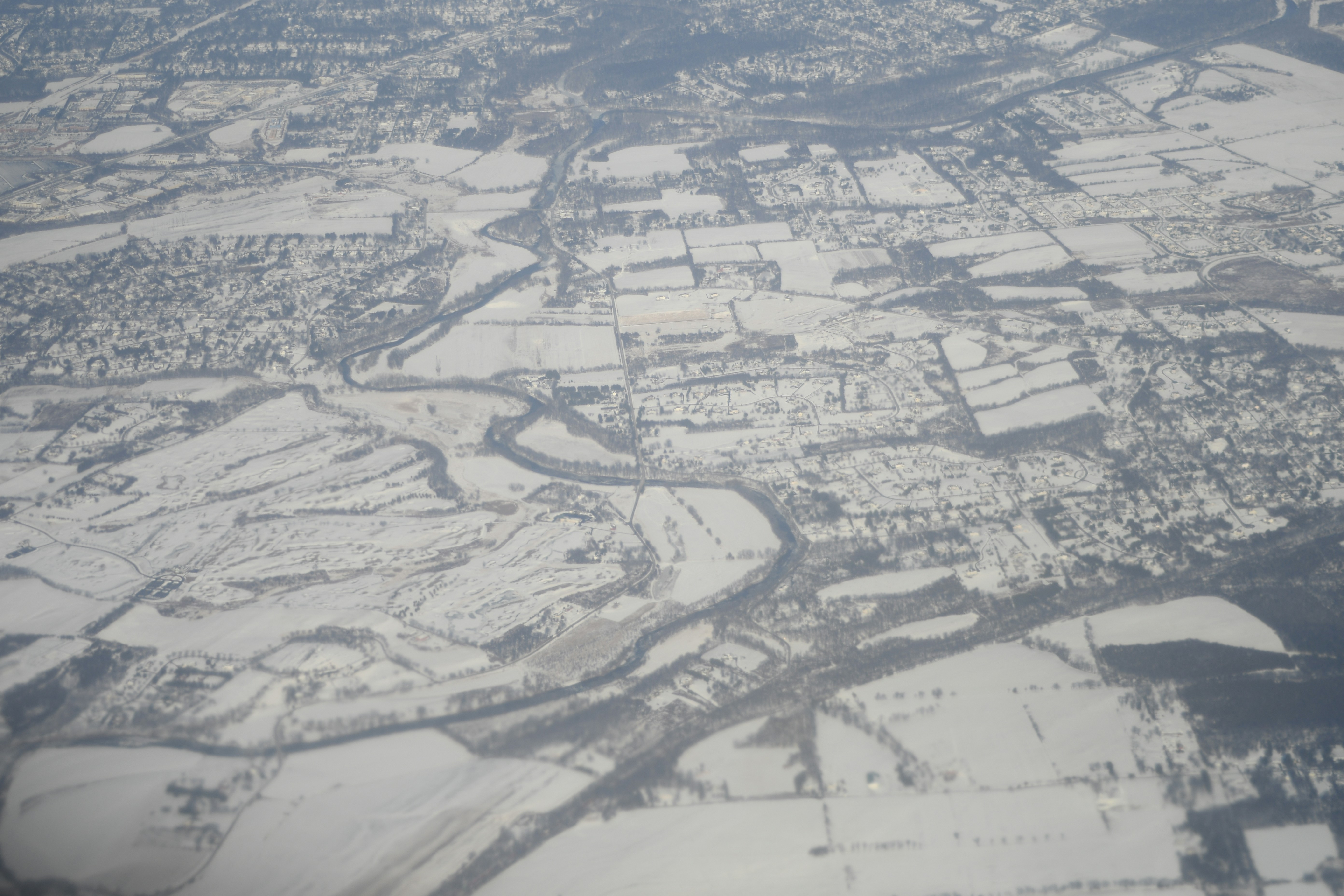 Snowbound Fields: Aerial Patchwork Overhedged Rivers