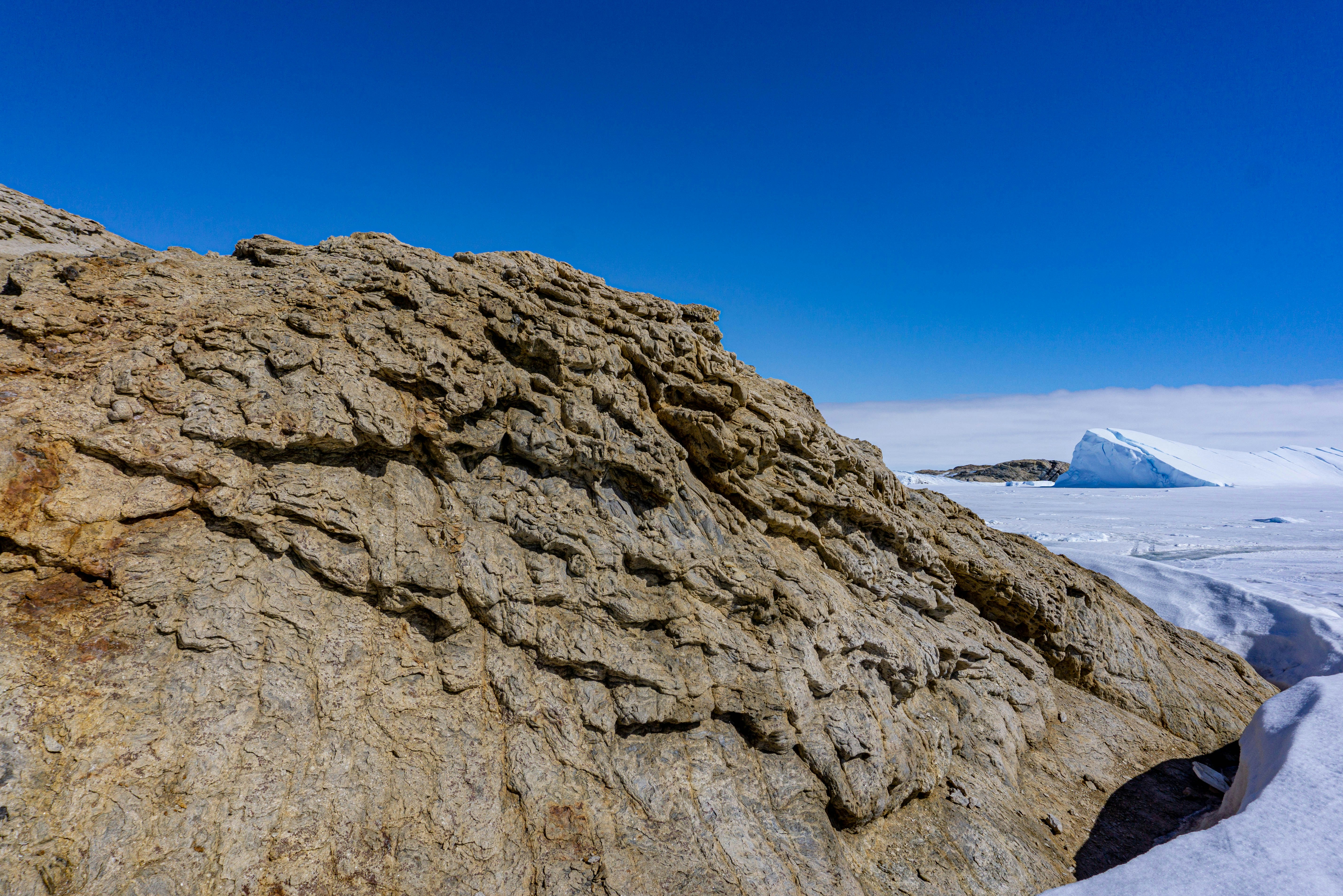 A rocky outcropping with snow on the ground photo – Free Antarctica ...
