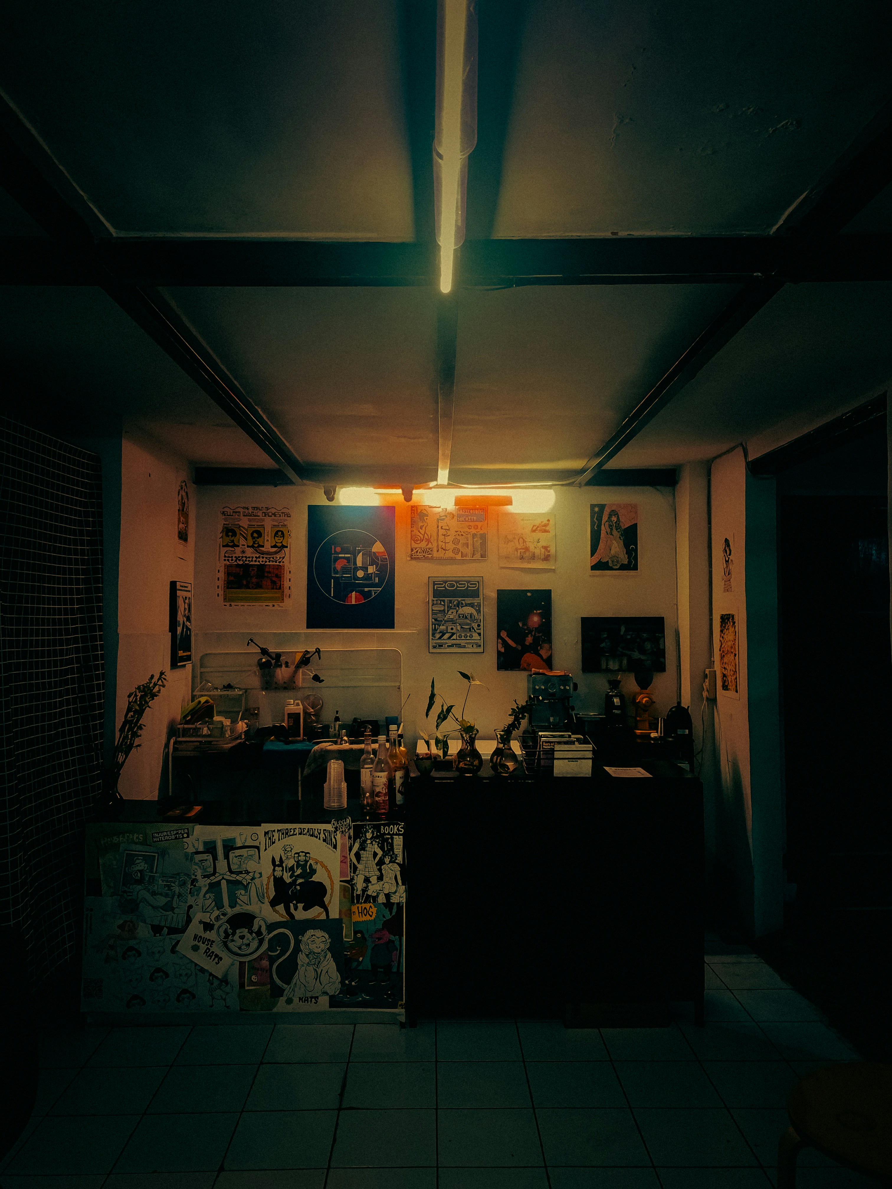 A dimly lit room with posters on the wall photo – Free Architecture ...