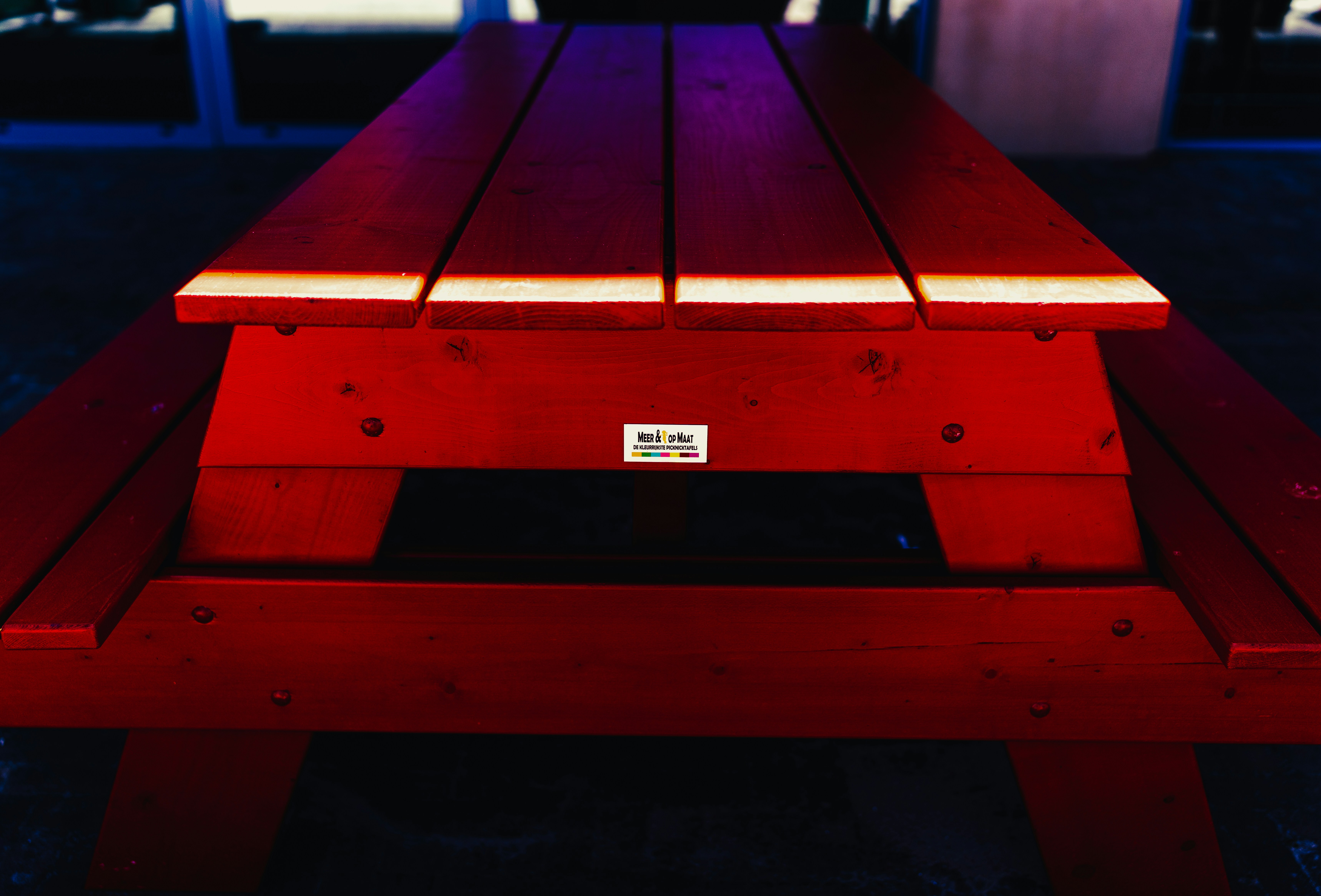 A red picnic table with a purple light behind it photo – Free Bench ...