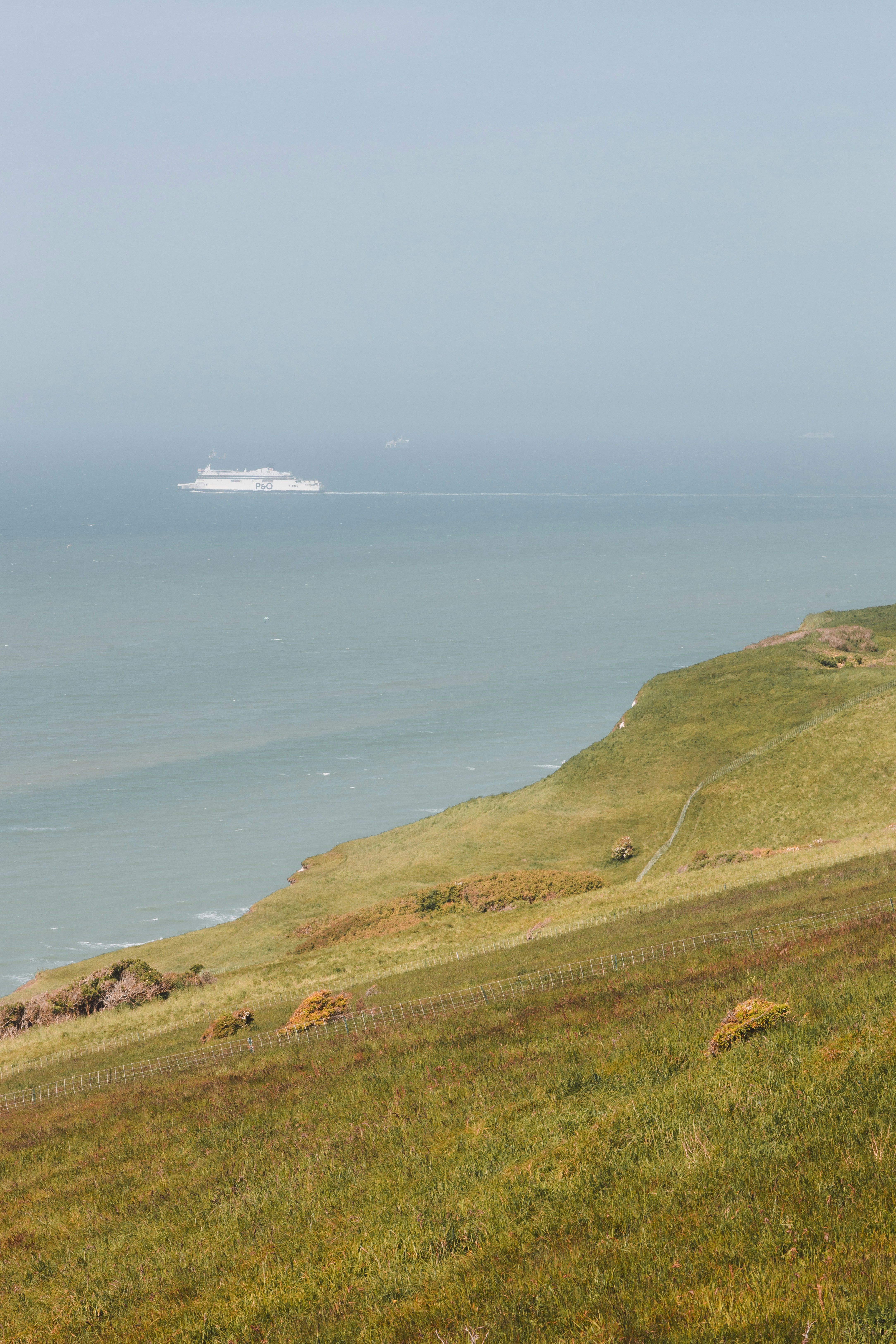 Coastal Clifftop Lookout with a Distant Vessel
