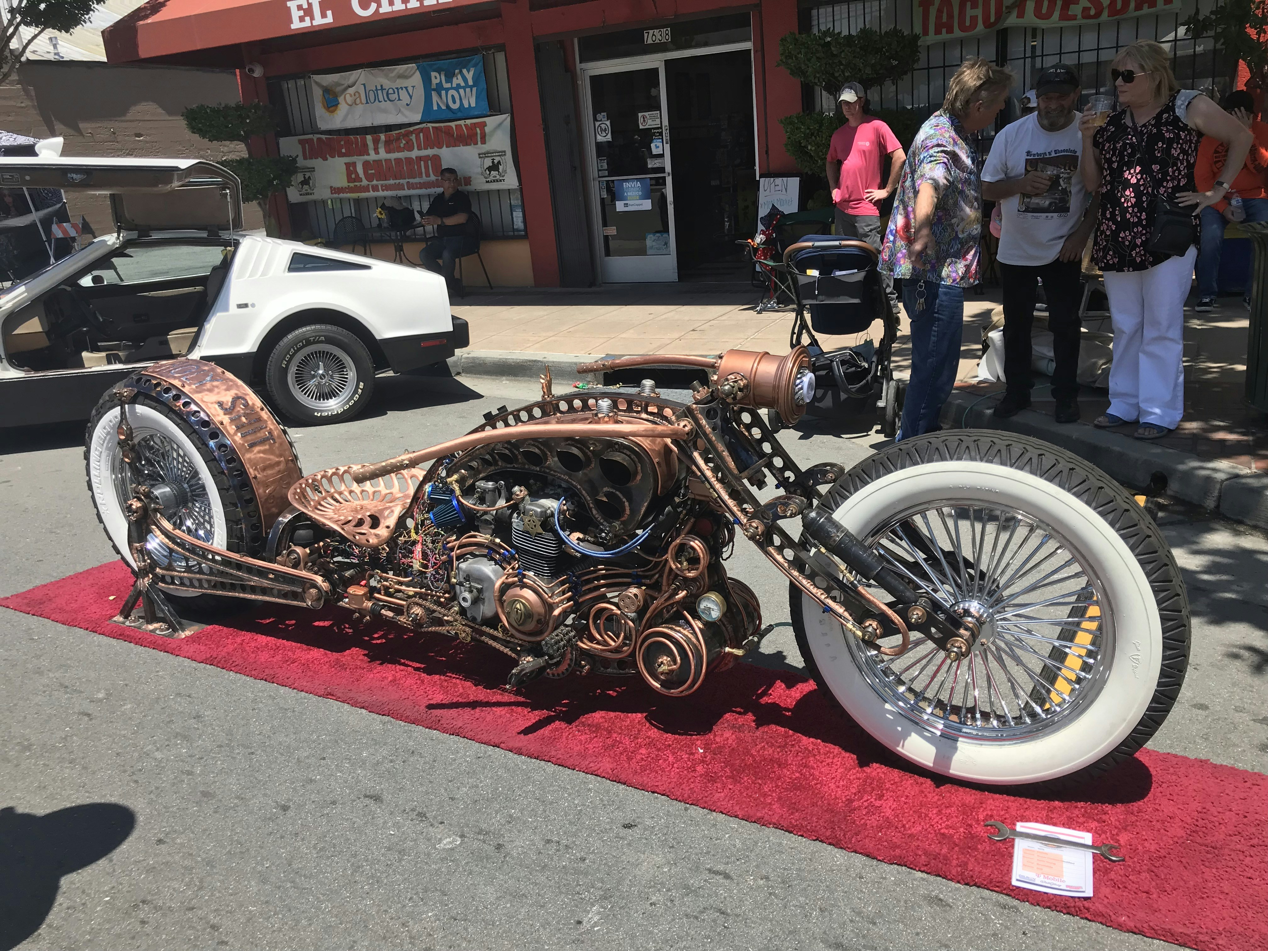 Red Carpet Iron Horse: A Vintage Motorcycle on Main Street