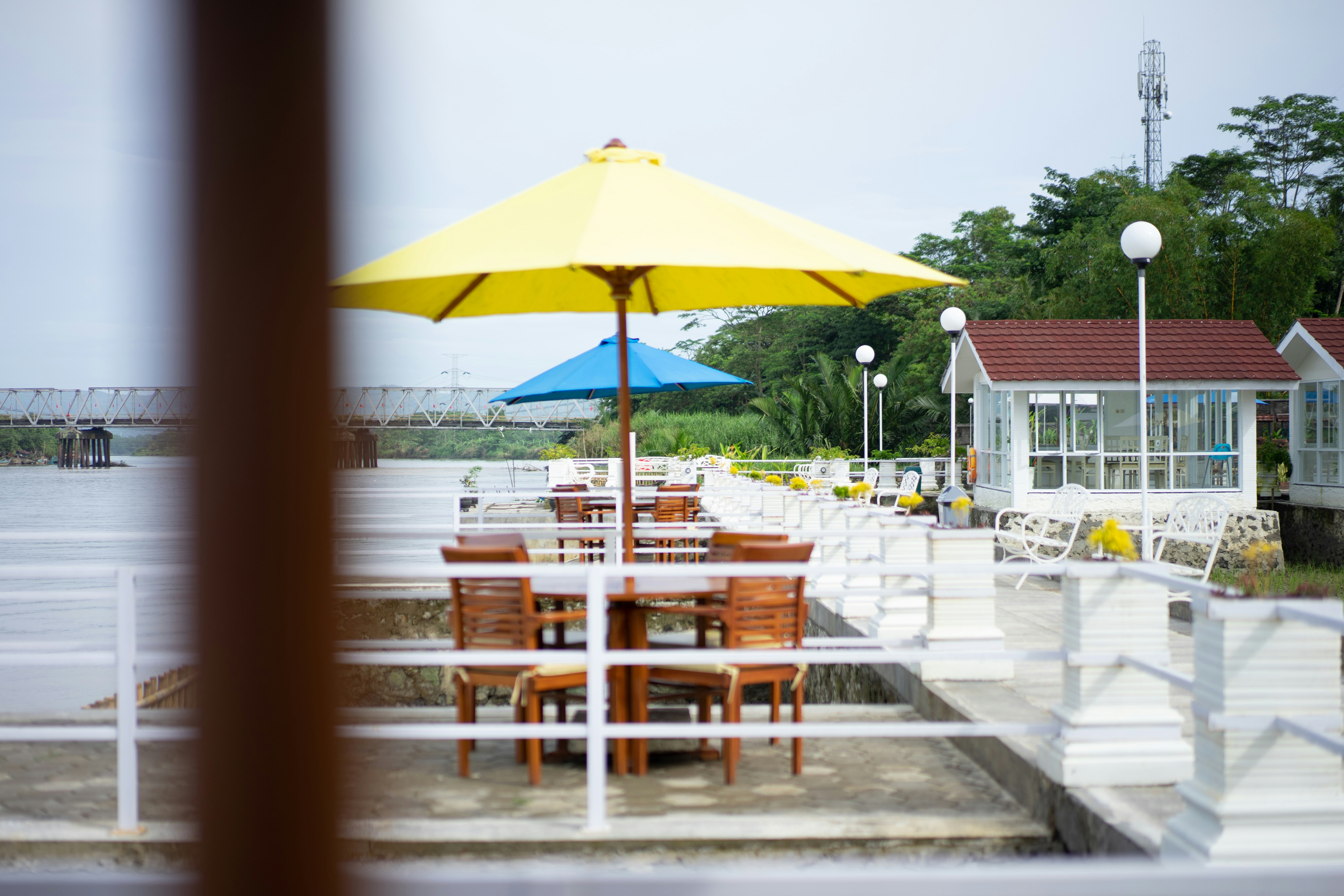 Yellow Umbrella Over Quiet Seaside Café