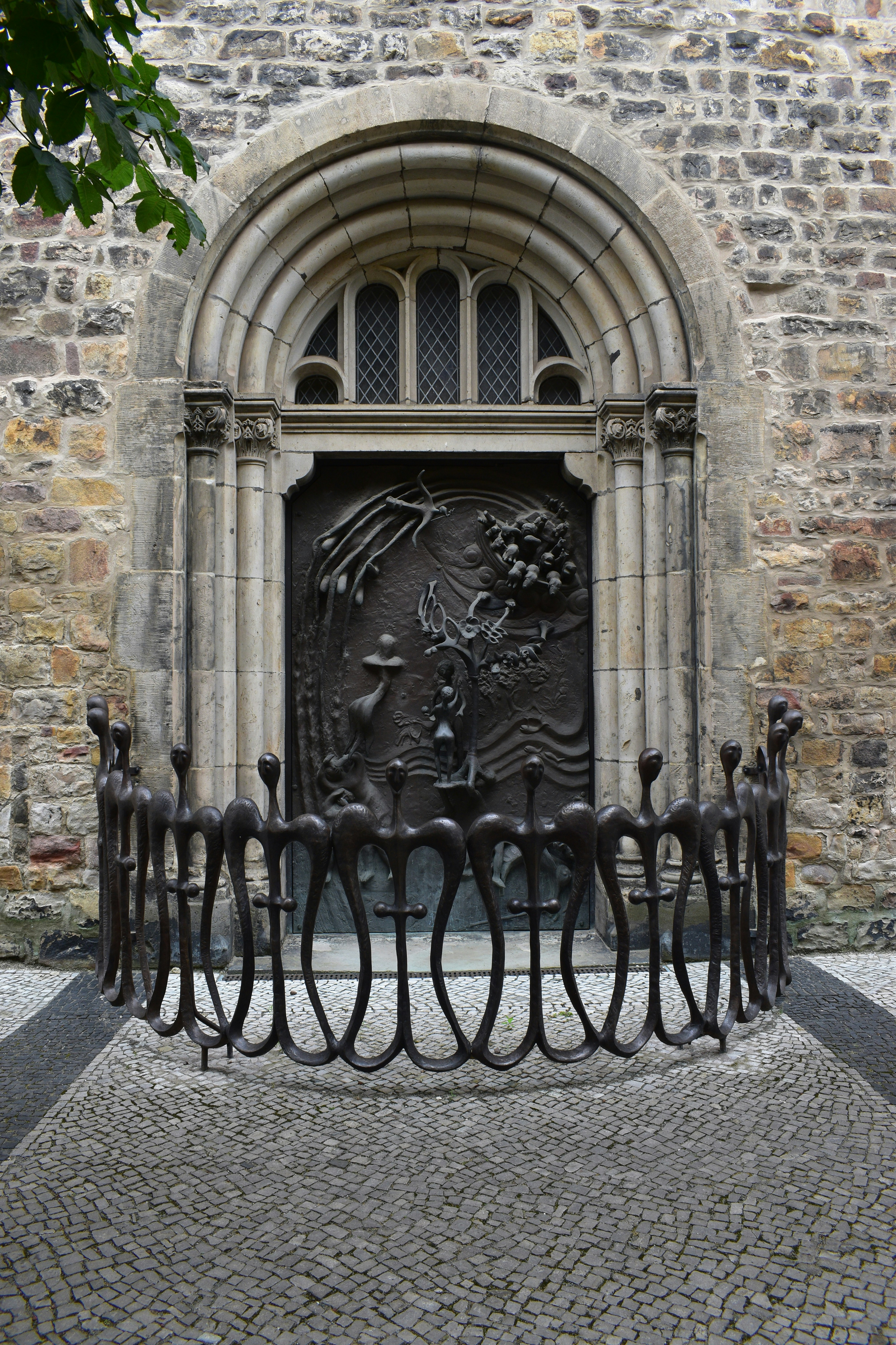 Dragon-Relief Portal: A Wrought-Iron Gate in Weathered Stone