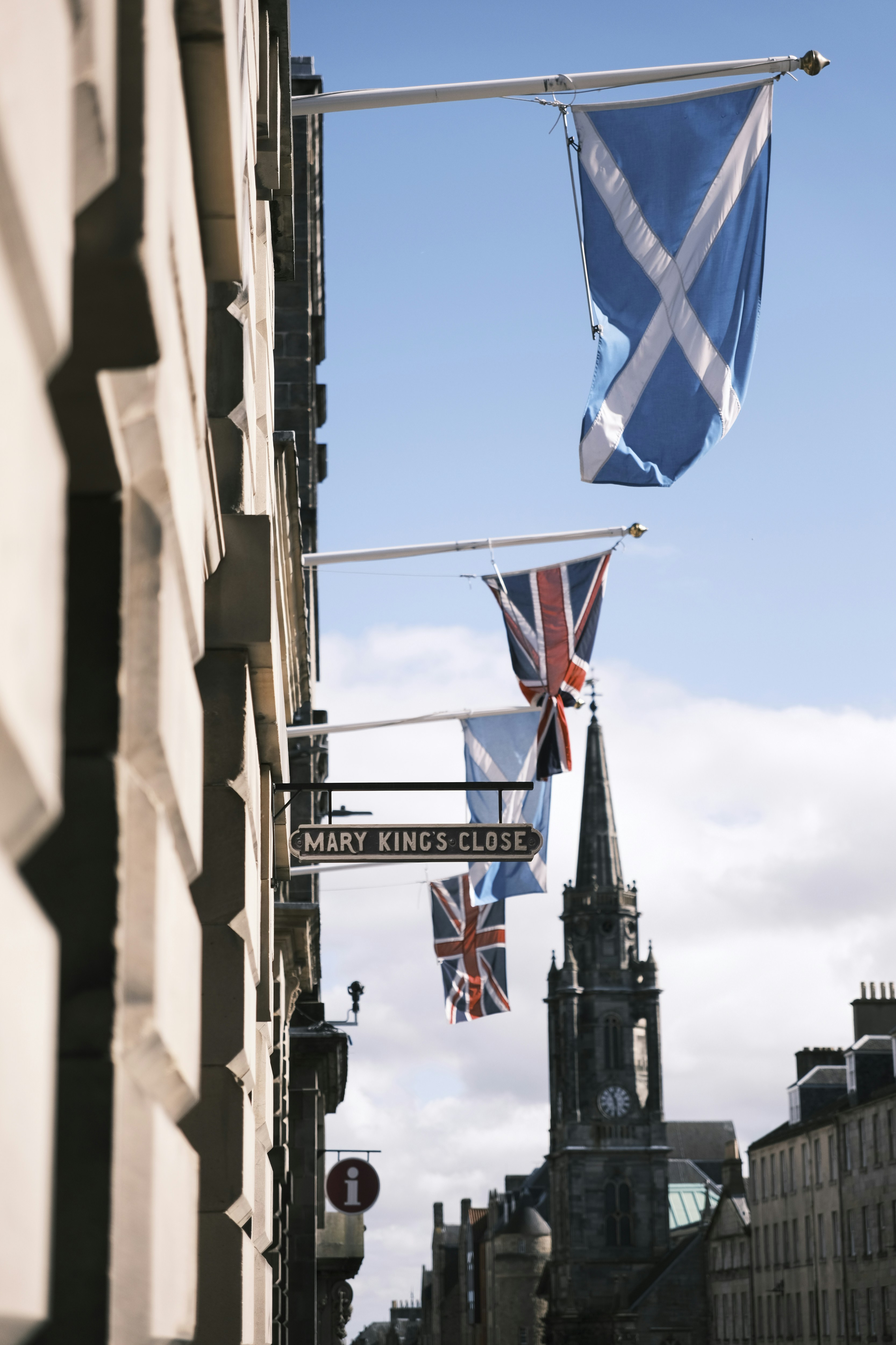 A city street with flags hanging from the side of buildings photo ...