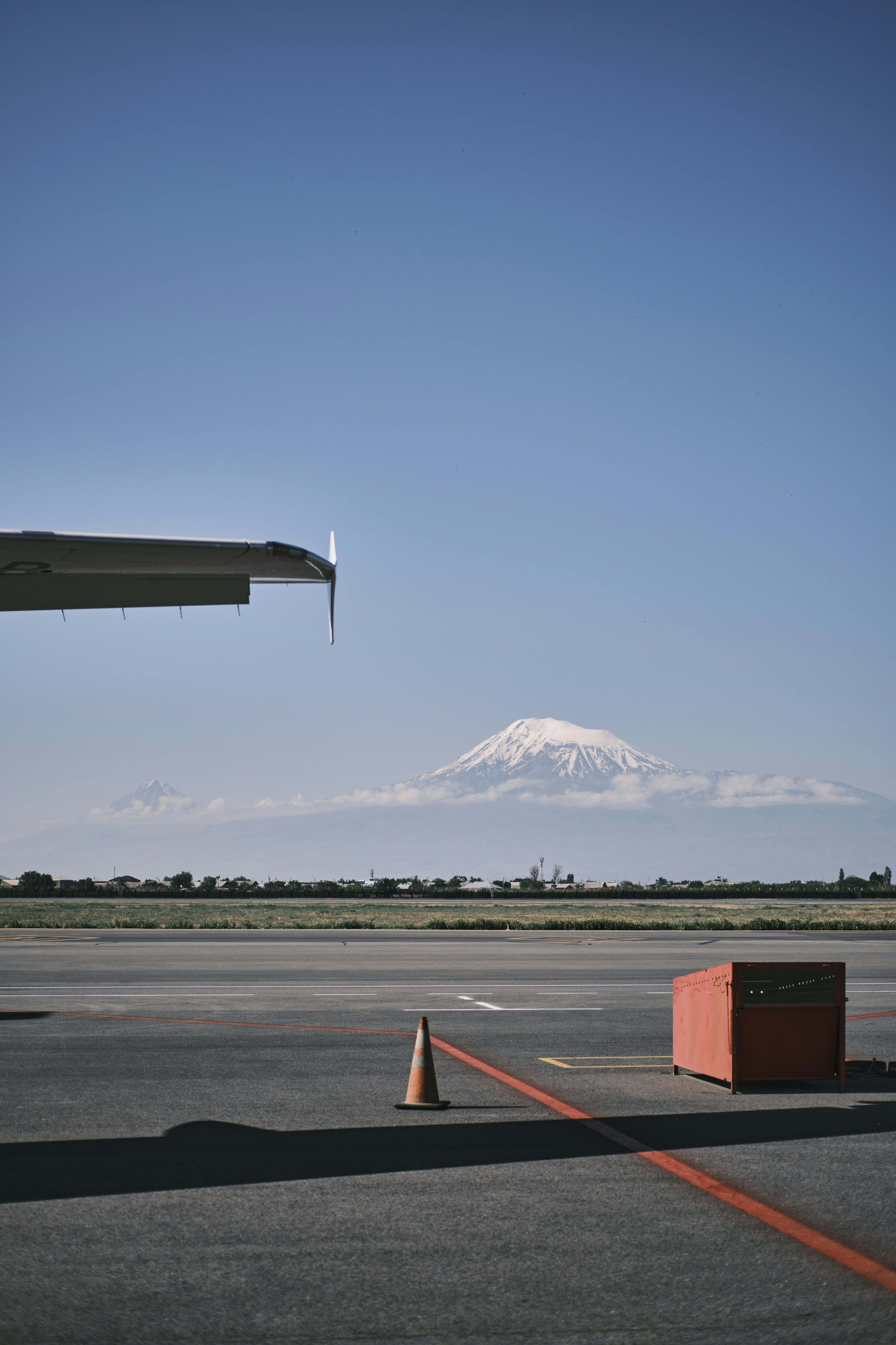 Wing at the Edge, Mount Fuji Rising Beyond the Tarmac