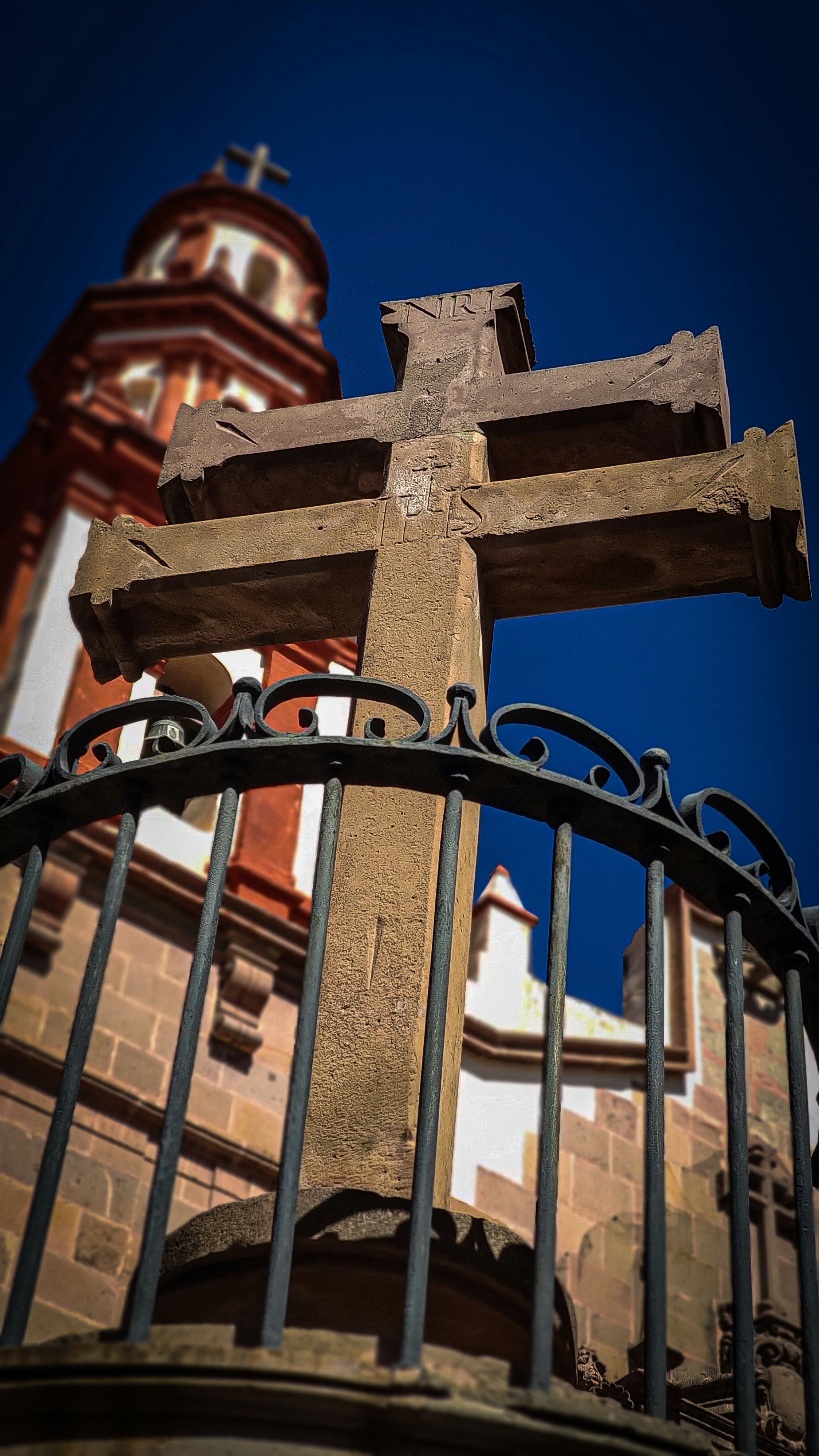 Cross and Gate: A Weathered Sentinel Over the Fortress
