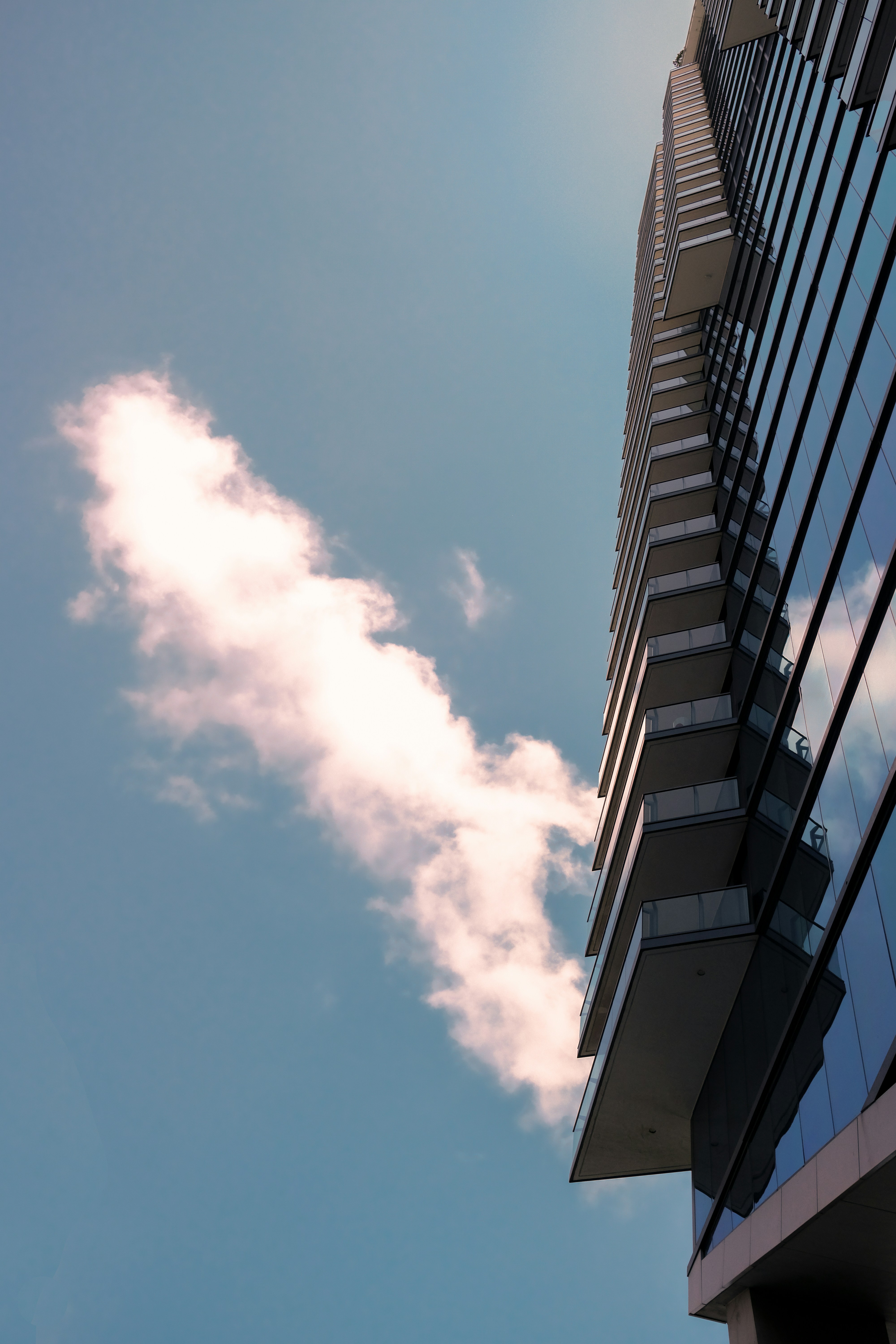 Skyward Facade: Balconies Ascend the Glass Tower