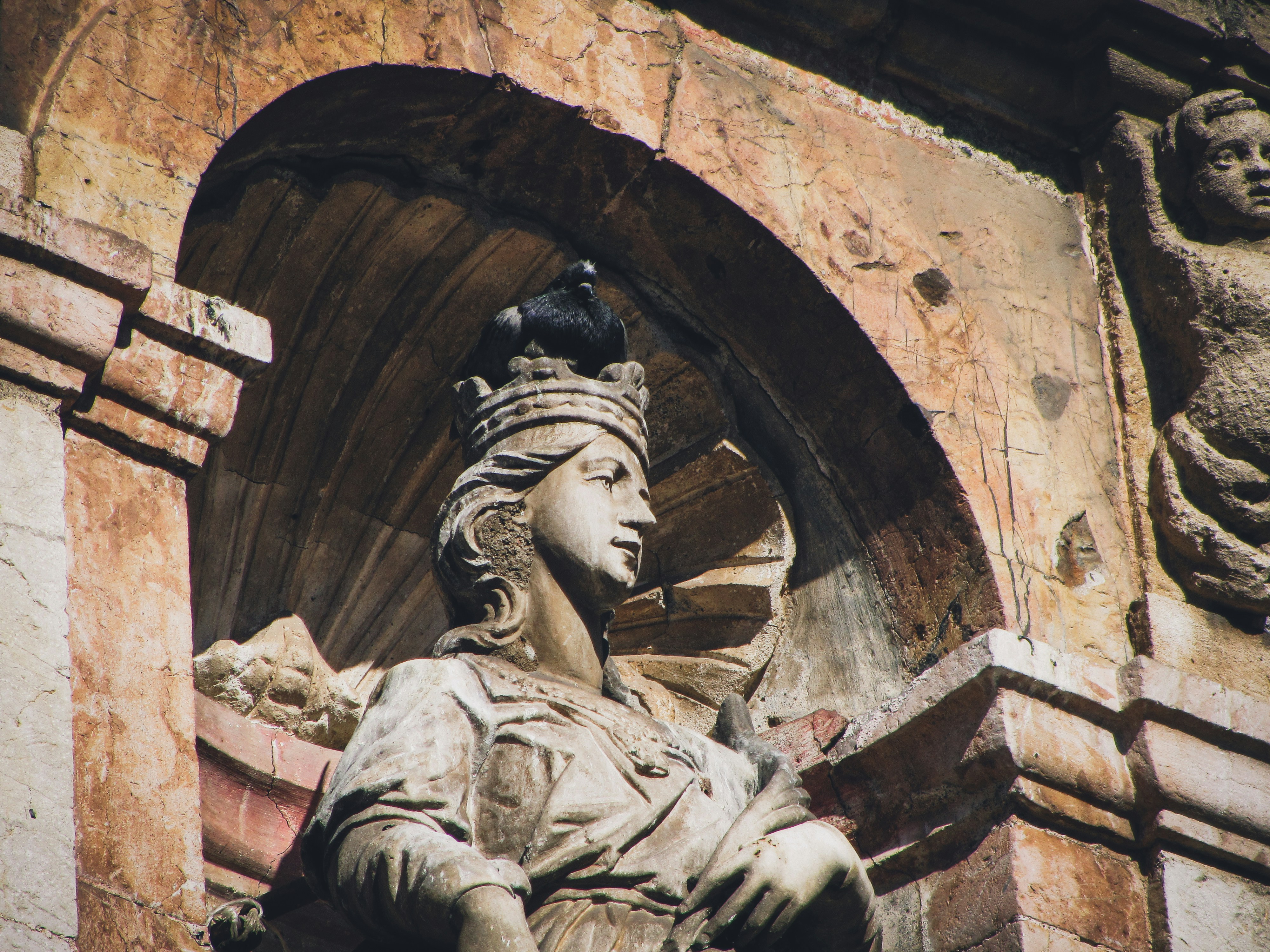 Archway Empress: Weathered Majesty Carved in Stone
