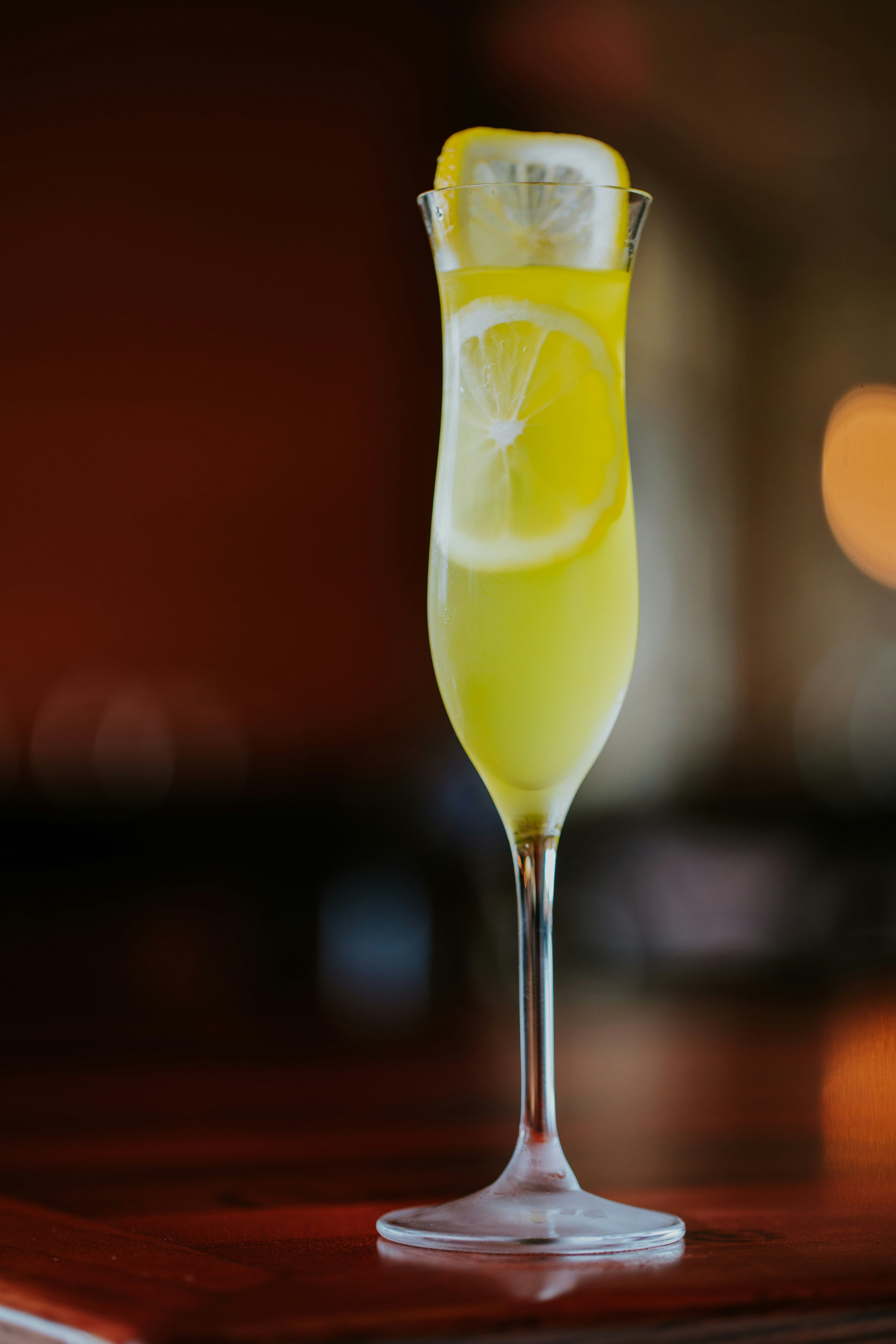 A glass of lemonade sitting on top of a wooden table photo – Free Food ...