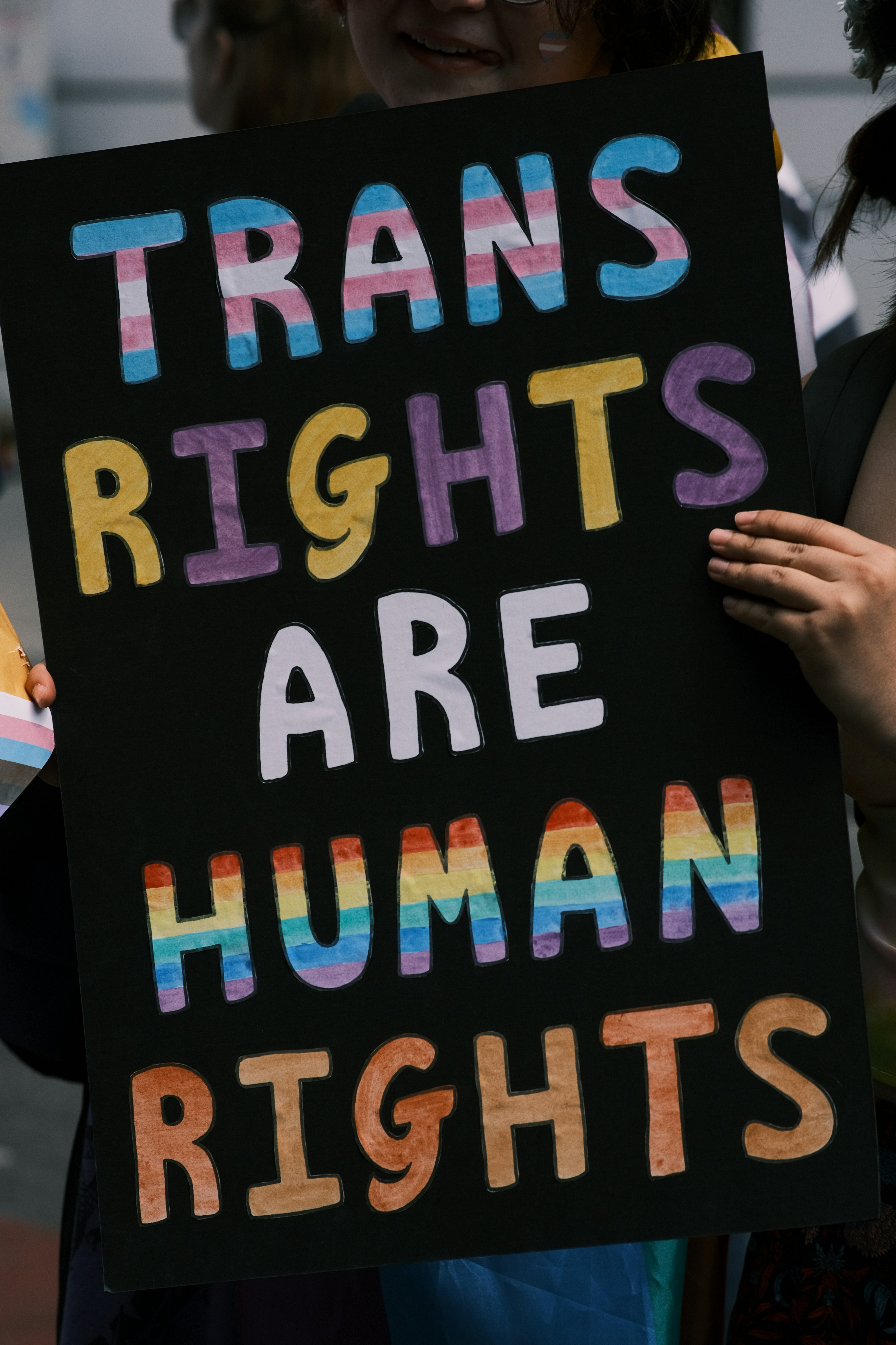 A person holding a sign that says transs rights are human rights photo ...