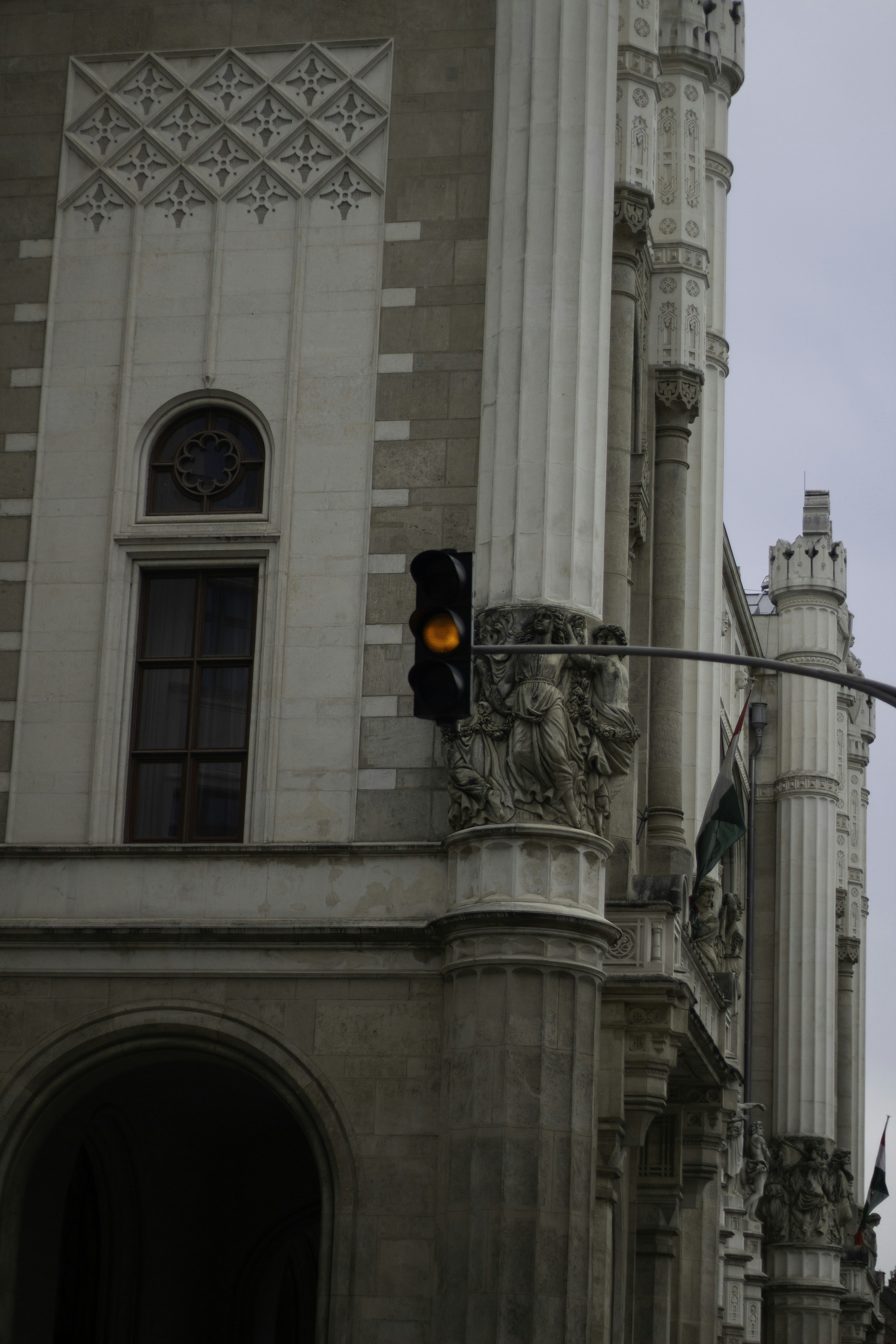 Amber Stoplight Framing an Ornate Facade