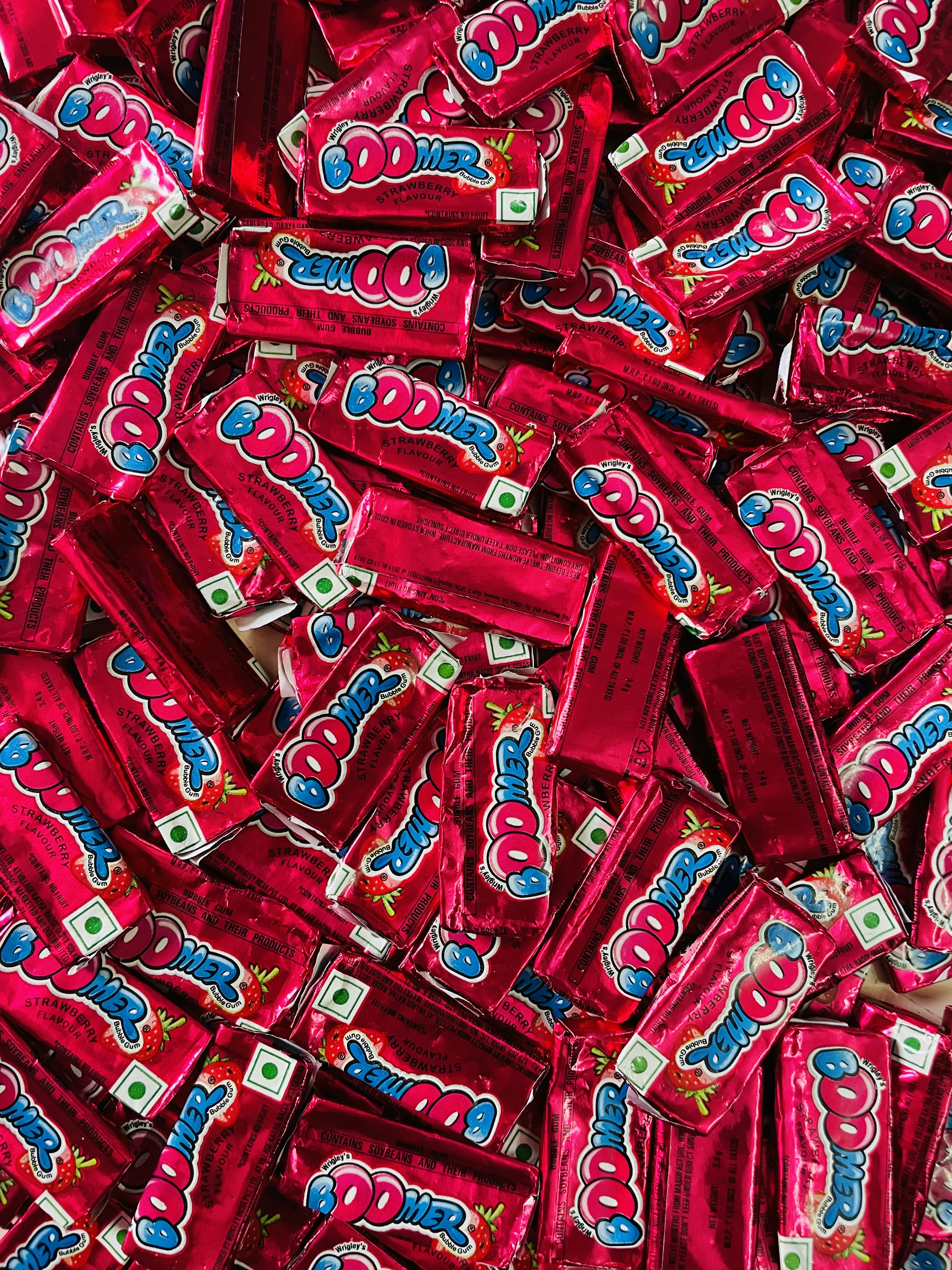 A pile of red candy bars sitting on top of a table photo – Free Food ...