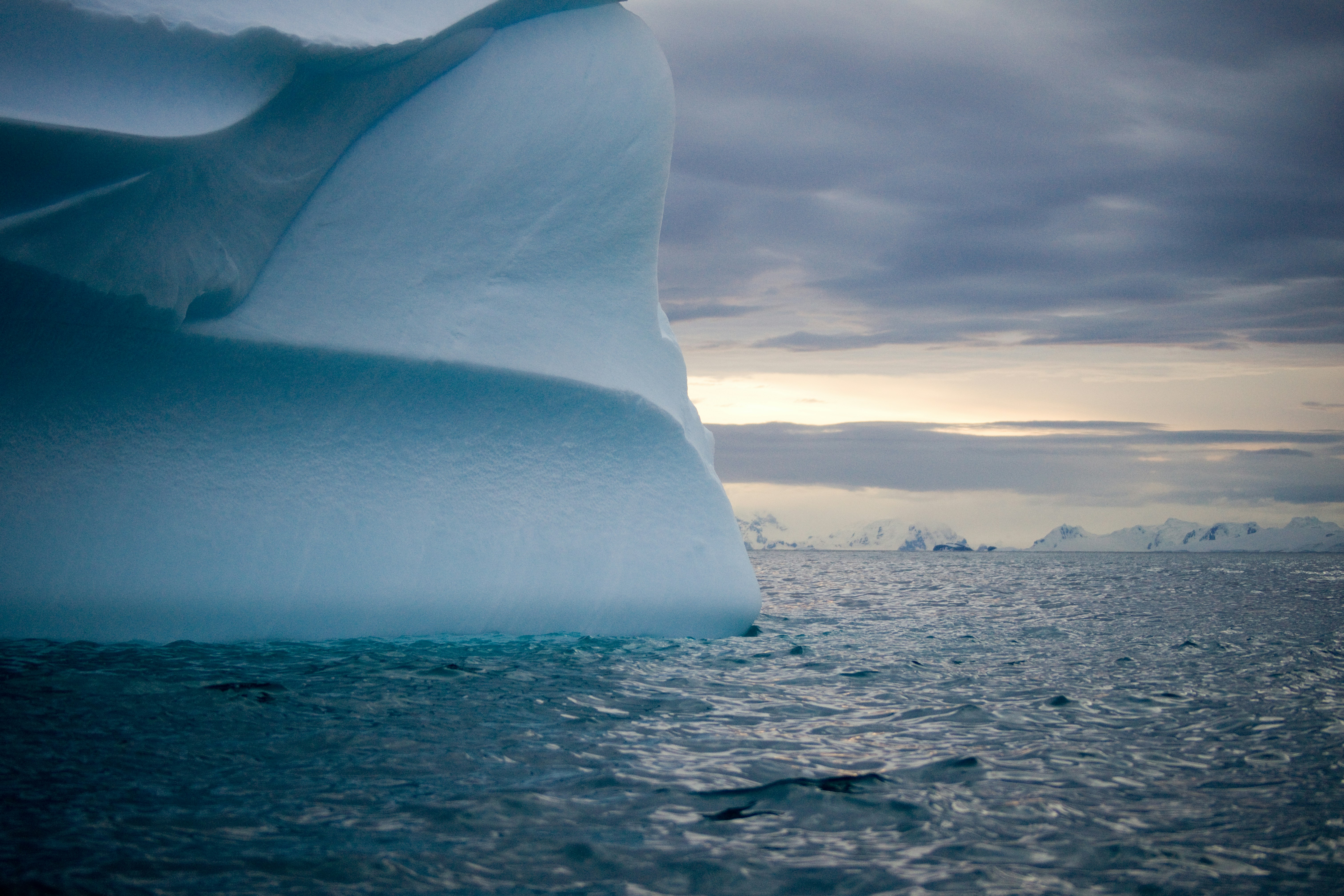 A large iceberg floating on top of a body of water photo – Free Ice ...