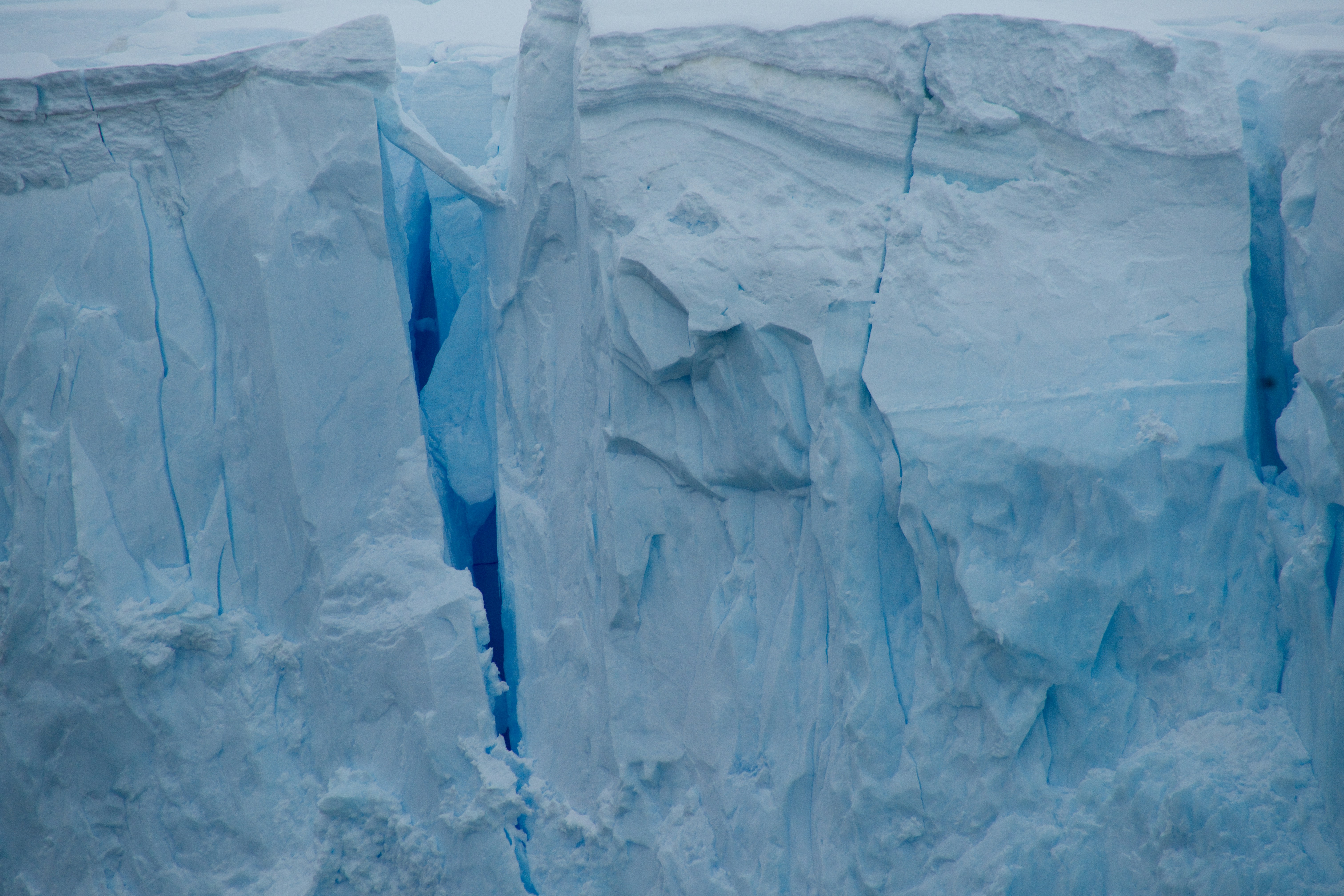 A large iceberg that is partially submerged in the water photo – Free ...