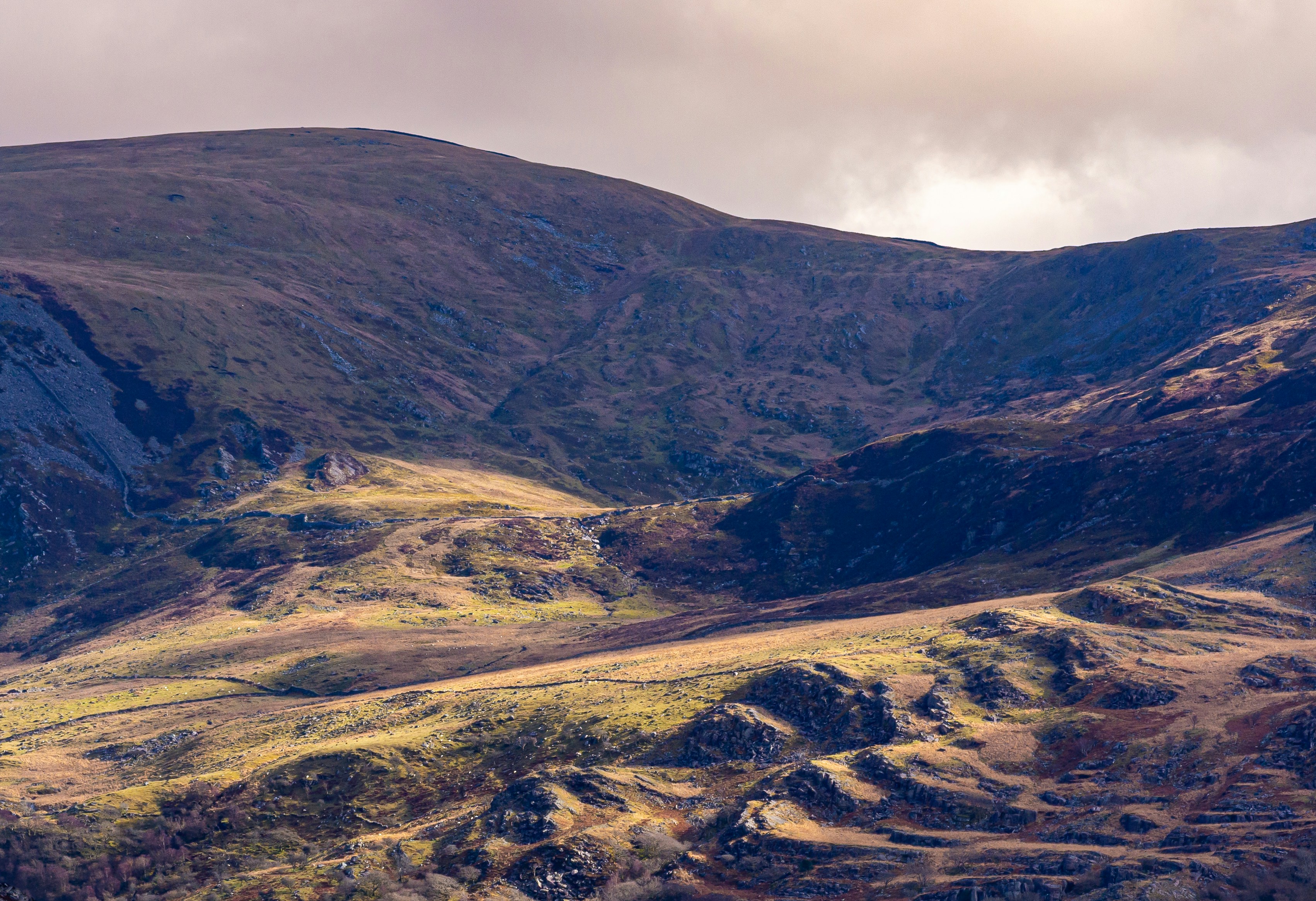 A view of a hilly area with a mountain in the background photo – Free ...