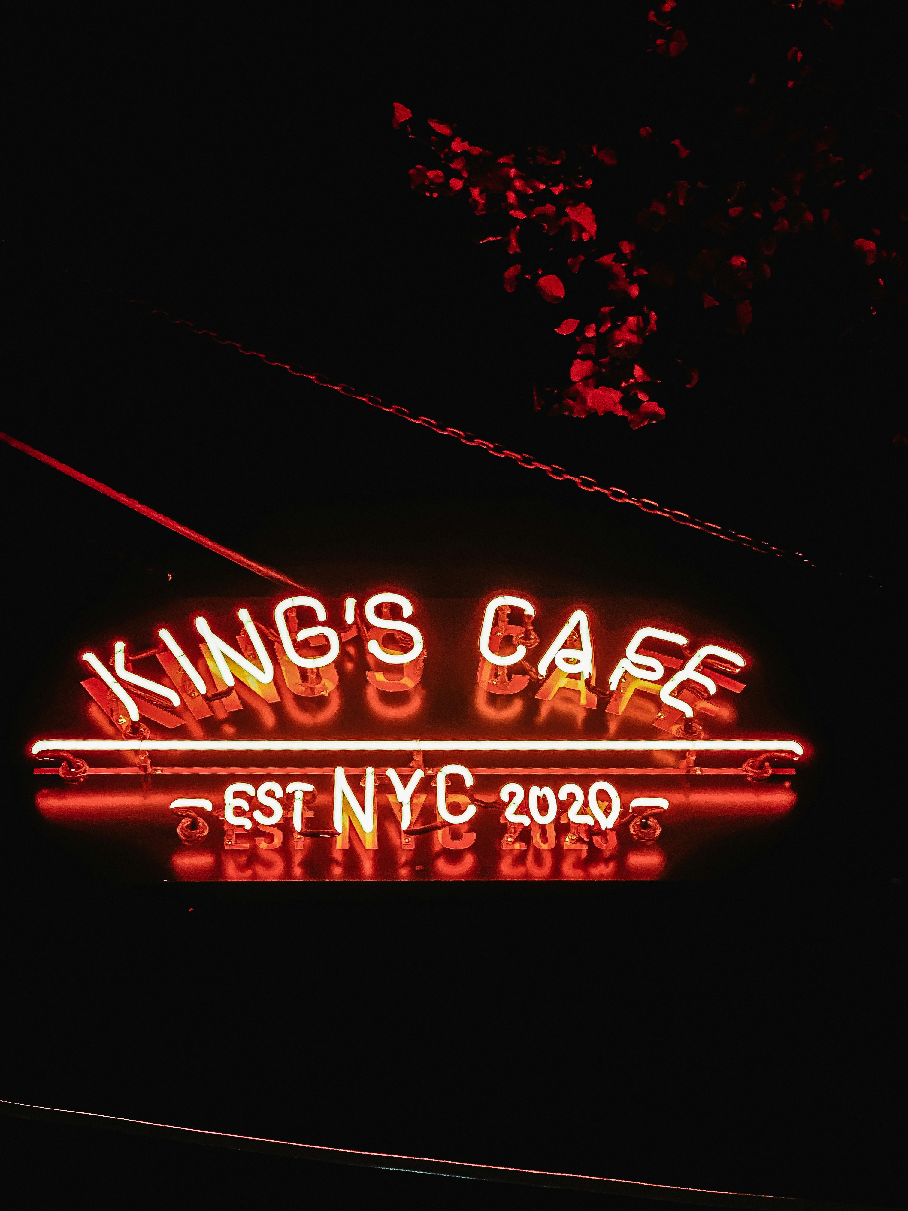 Neon Crown of King's Café: A Nighttime Reflection in Red