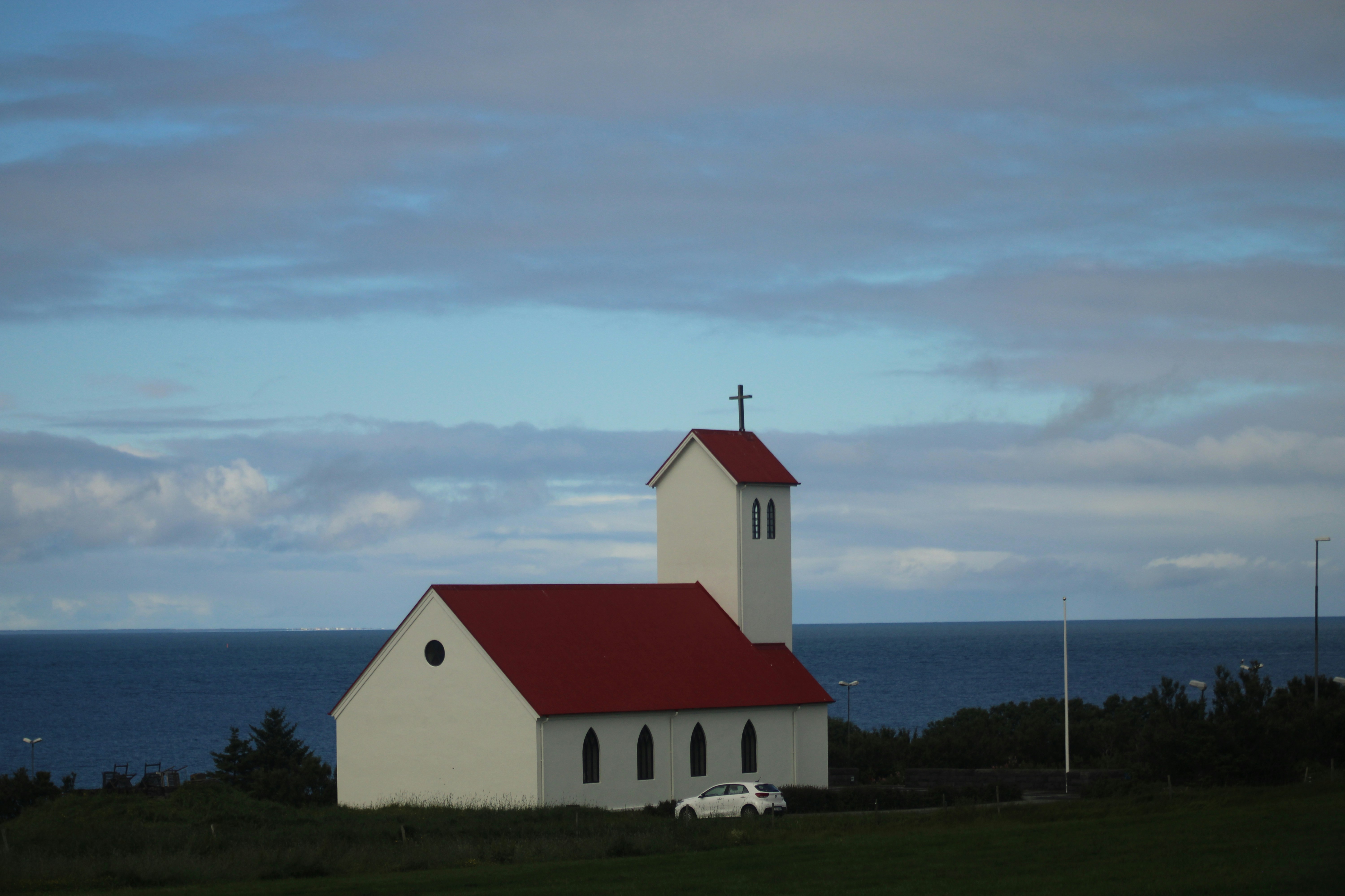 Crimson-roofed chapel by the calm sea