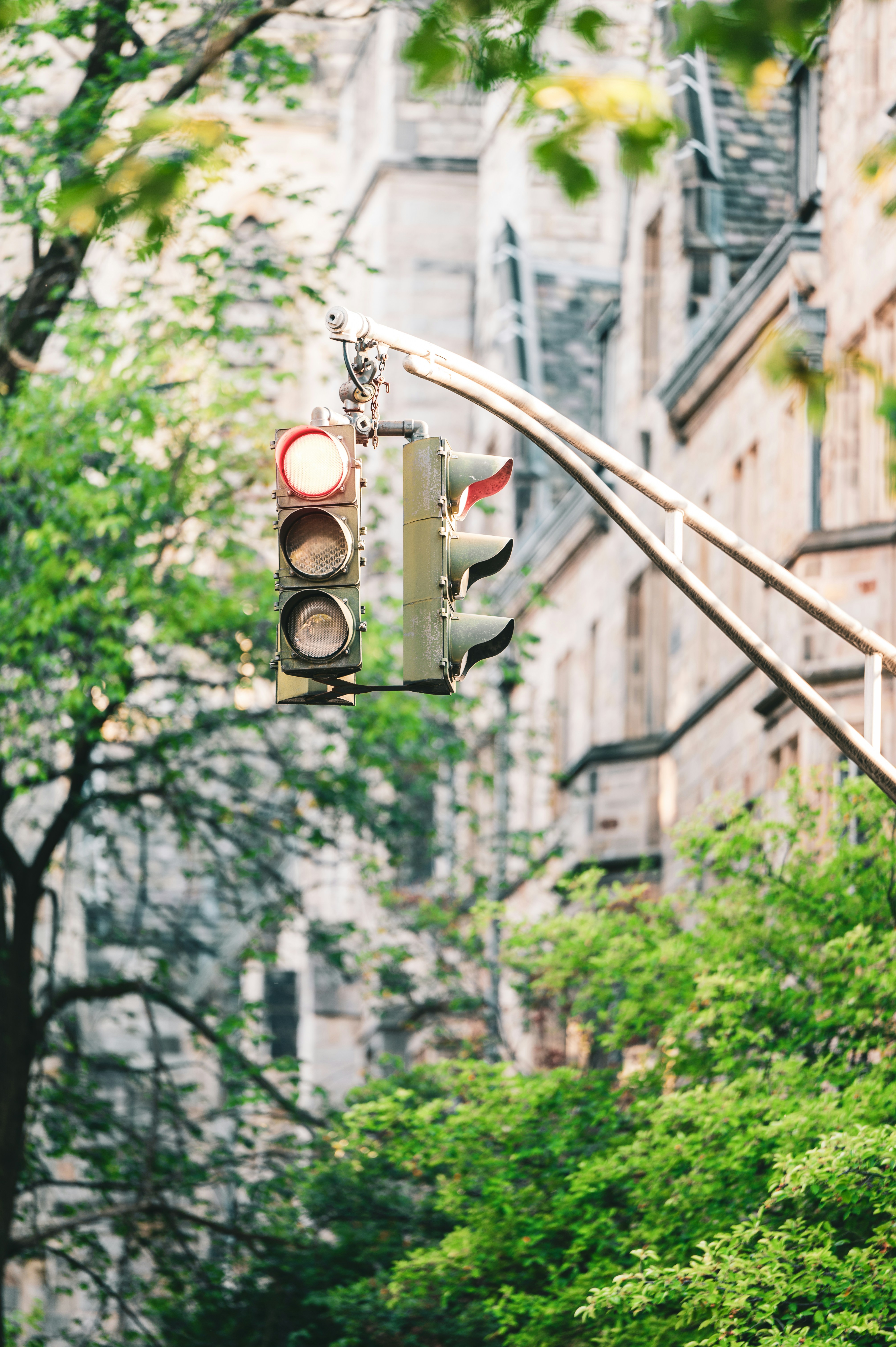 A traffic light hanging off the side of a building photo – Free Light ...