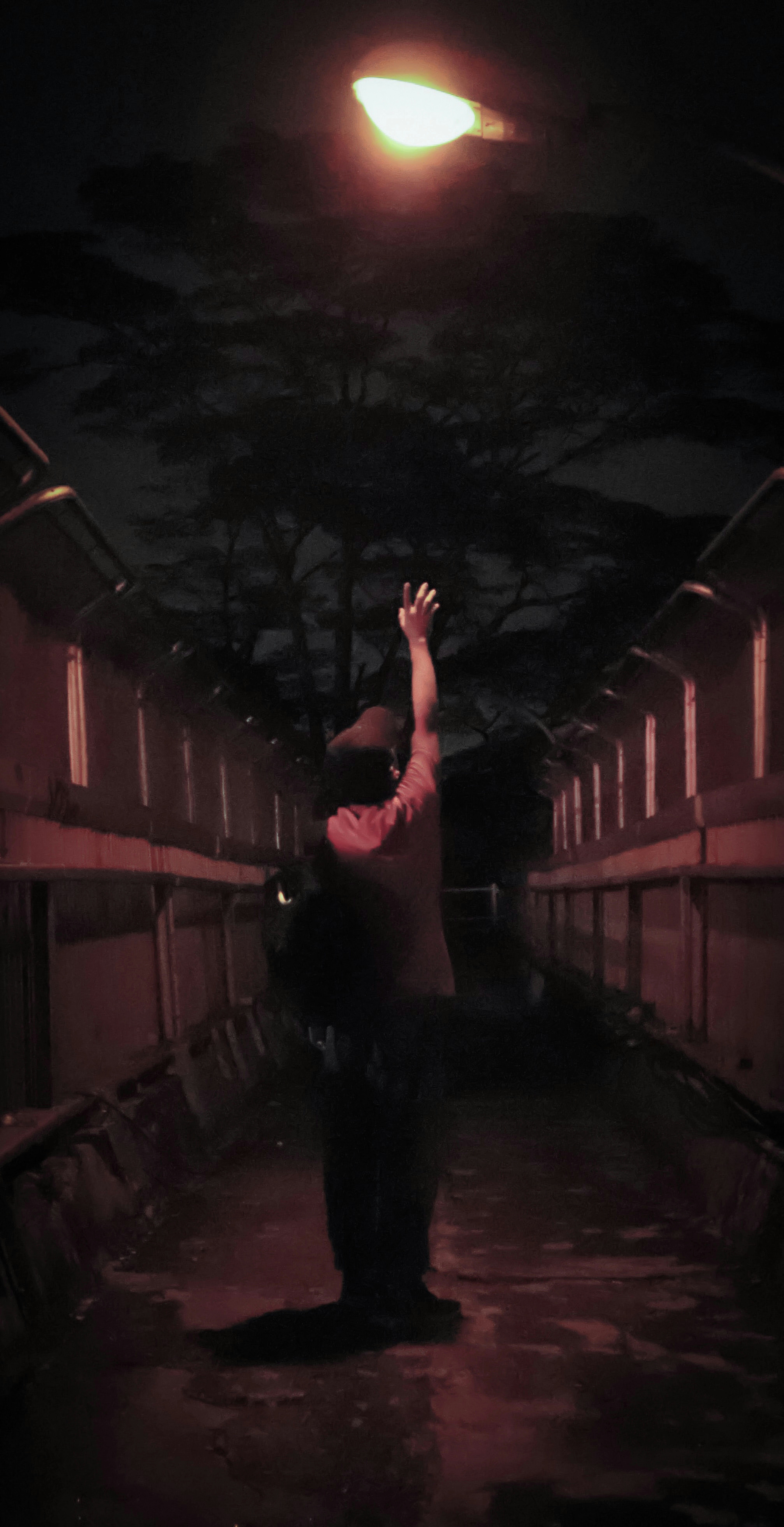 A person standing in a hallway at night photo – Free Lebak bulus Image ...