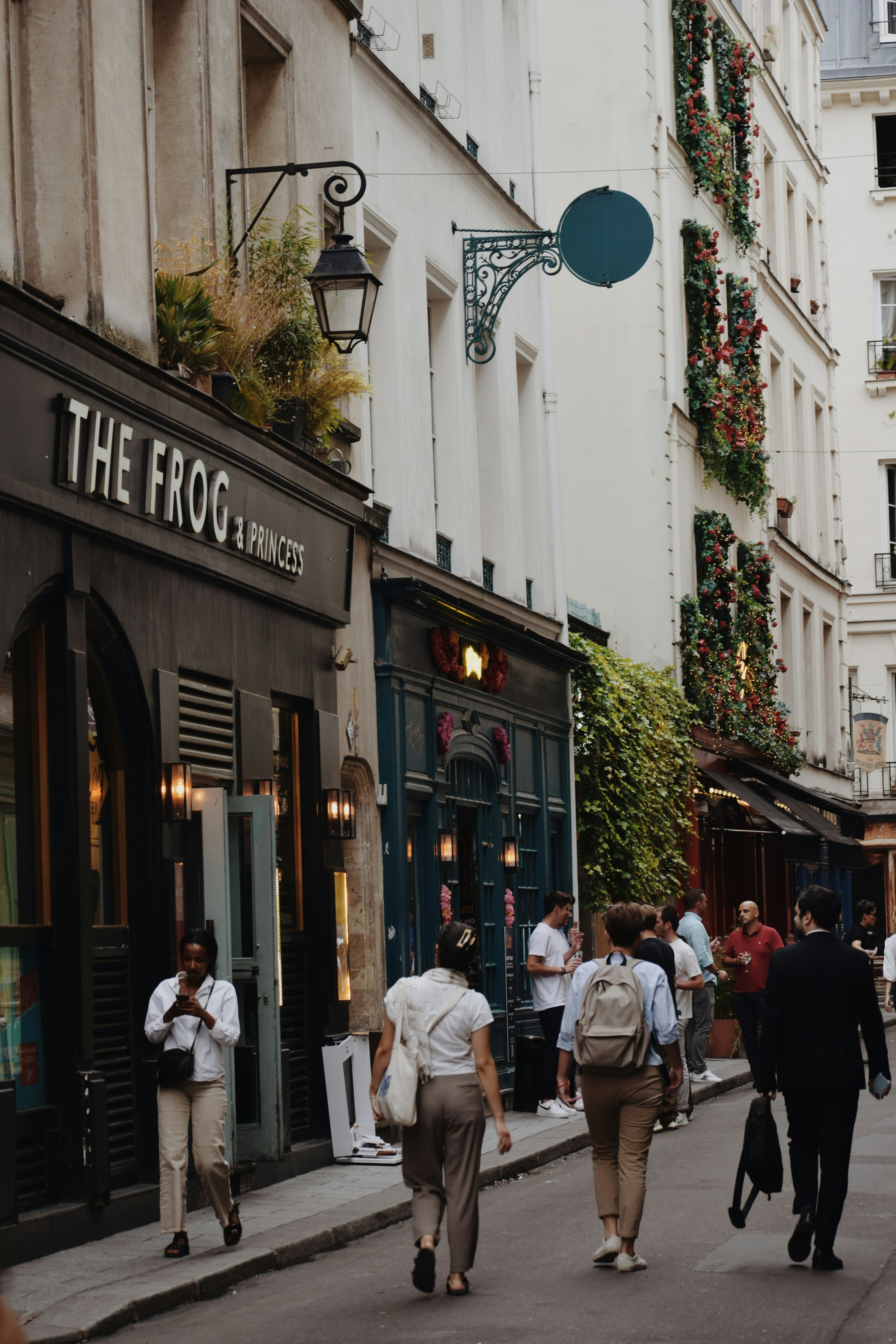 City Street Dialogue: People Walk the Narrow Chamfer of a Parisian Lane