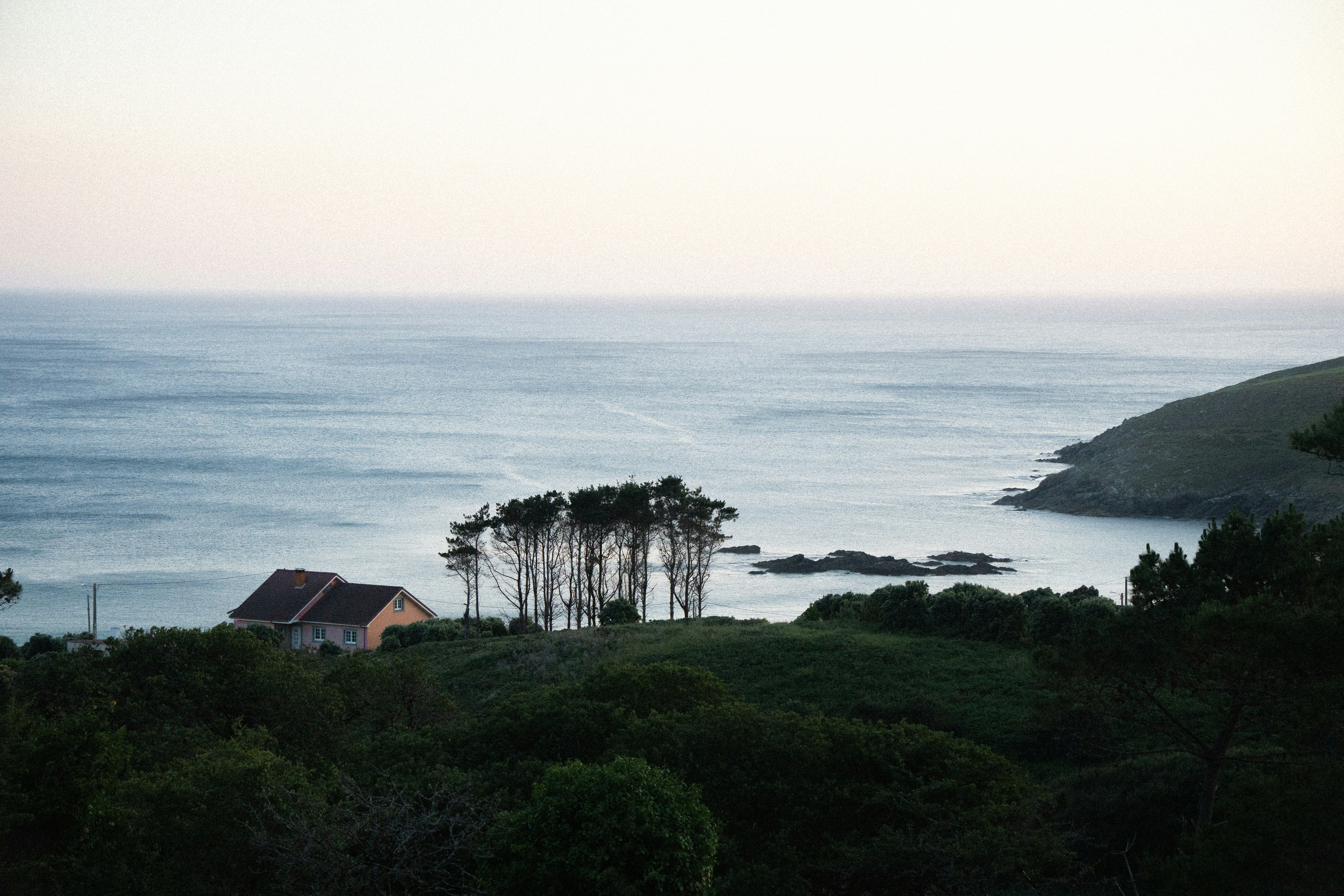 A house on a hill overlooking a body of water photo – Free Spanien ...