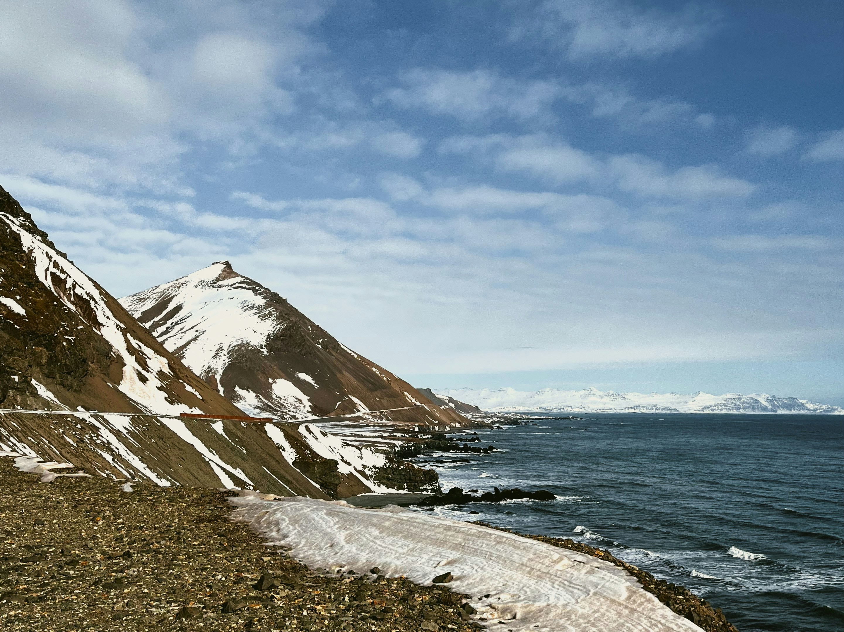 Snowbound Ridge Meets the Winding Coastal Road