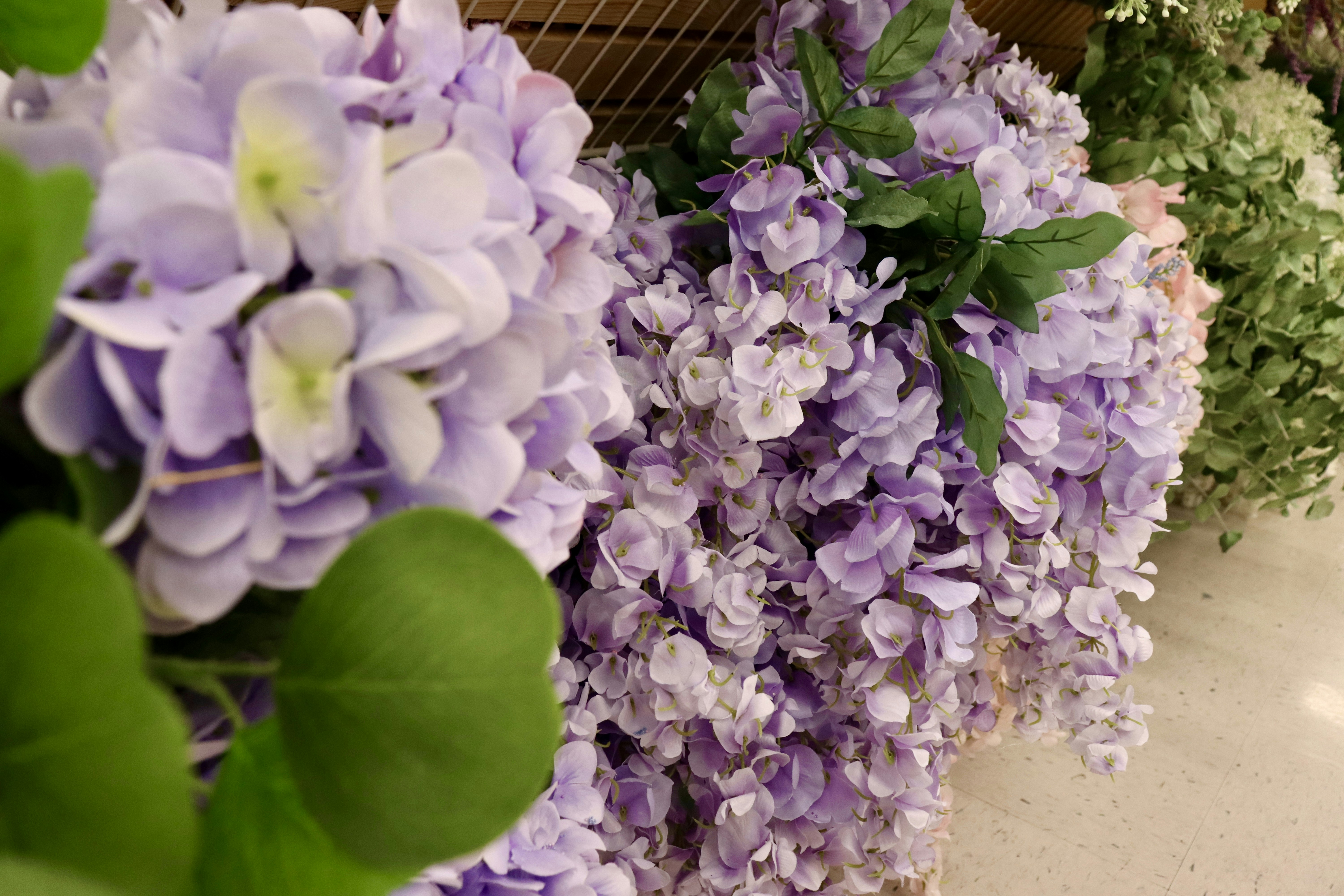 Pastel Hydrangea Parade: Lavender Bouquets Line a Quiet Store Aisle
