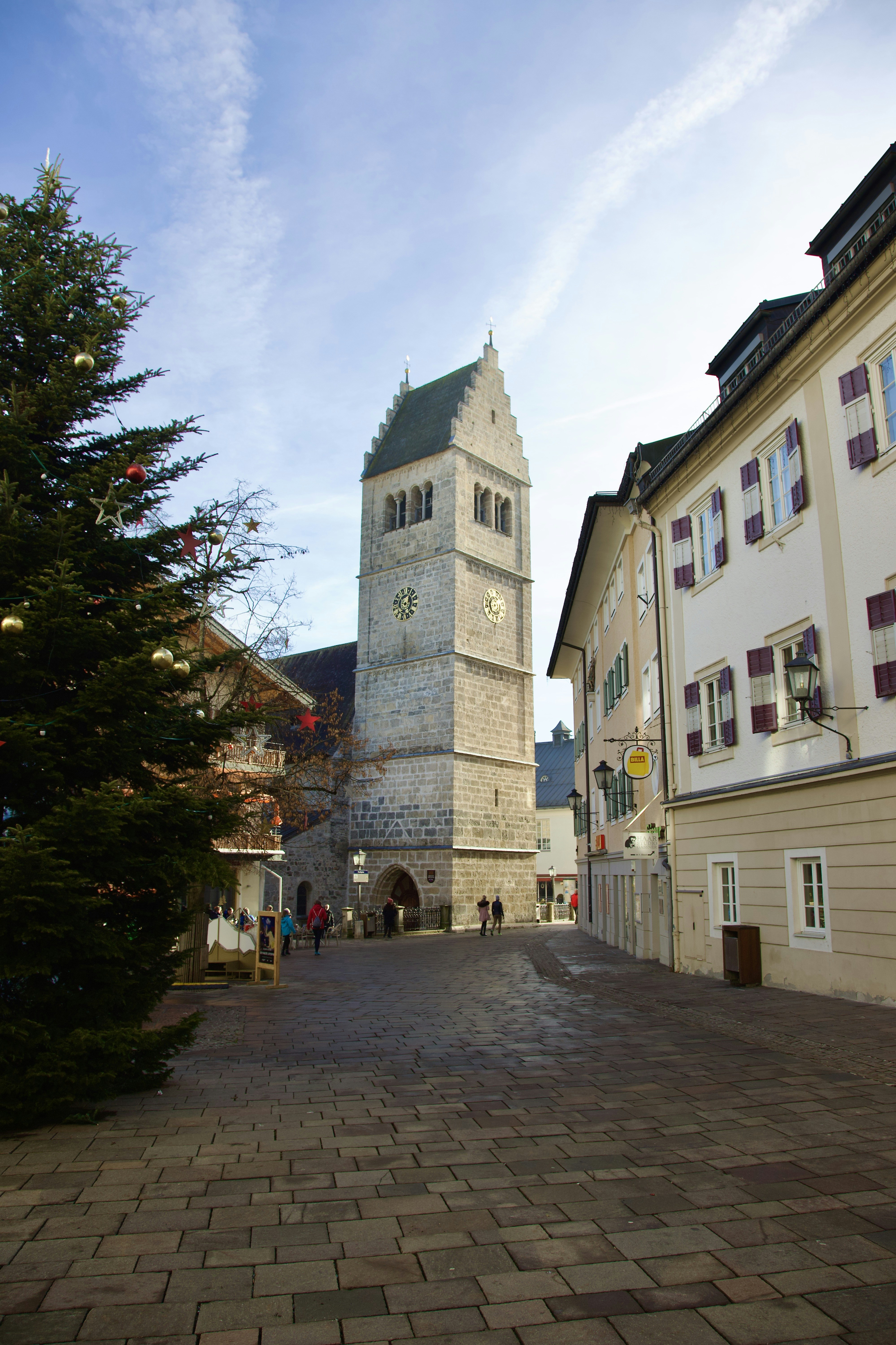 A tall clock tower towering over a city photo – Free Zell am see Image ...