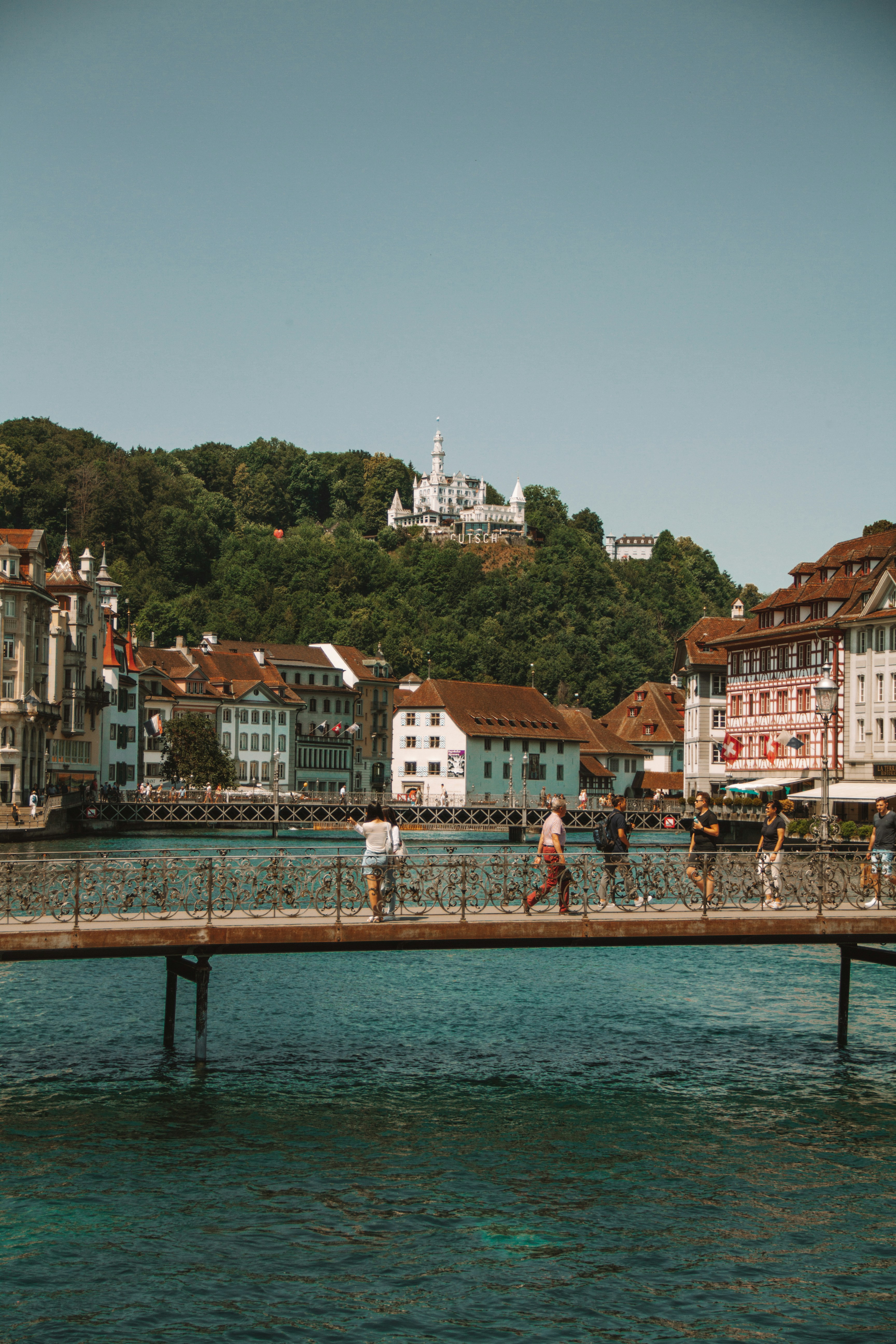 People walking across a bridge over a body of water photo – Free ...