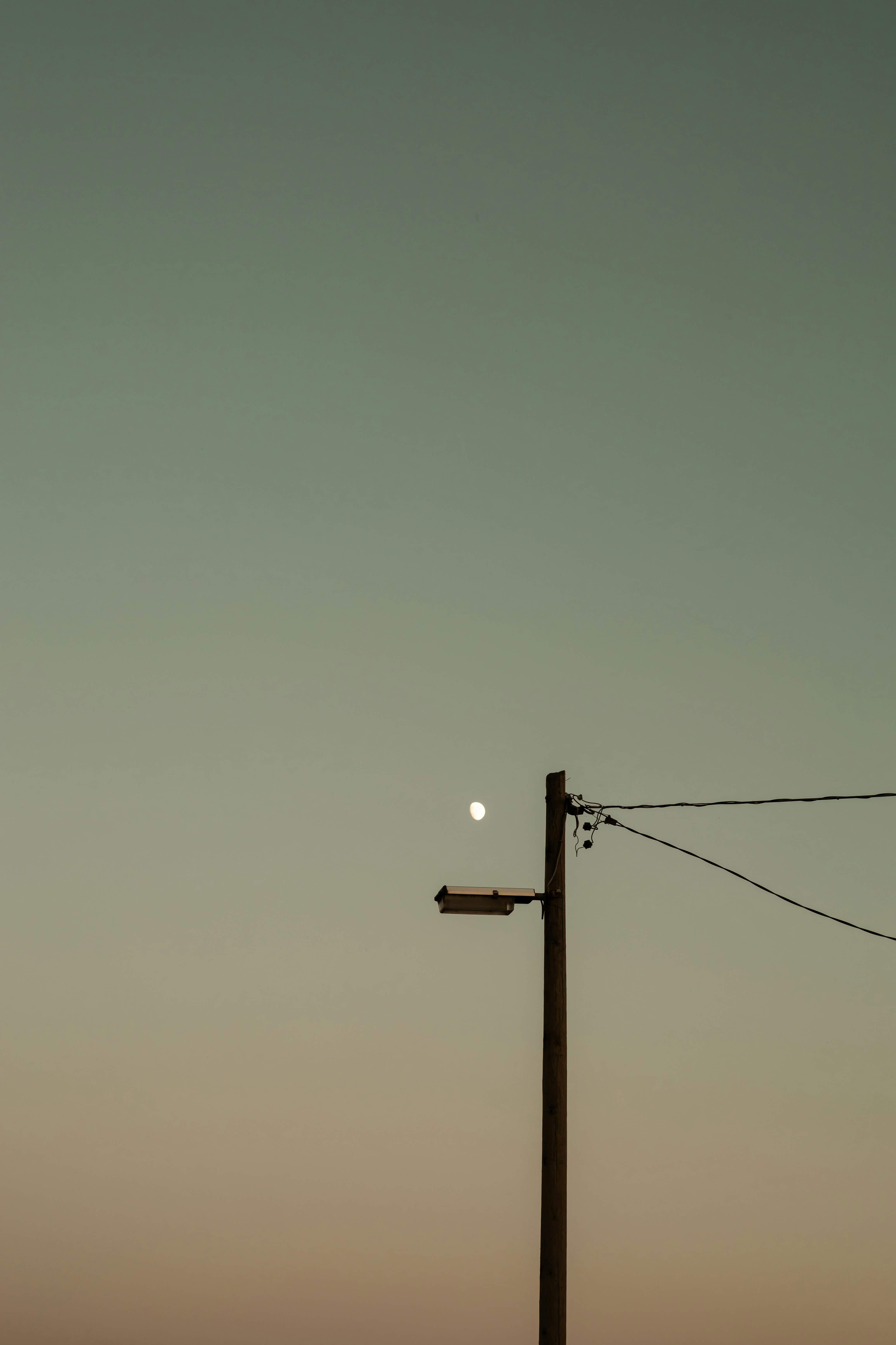 Moonlight Over a Quiet Utility Pole at Dusk