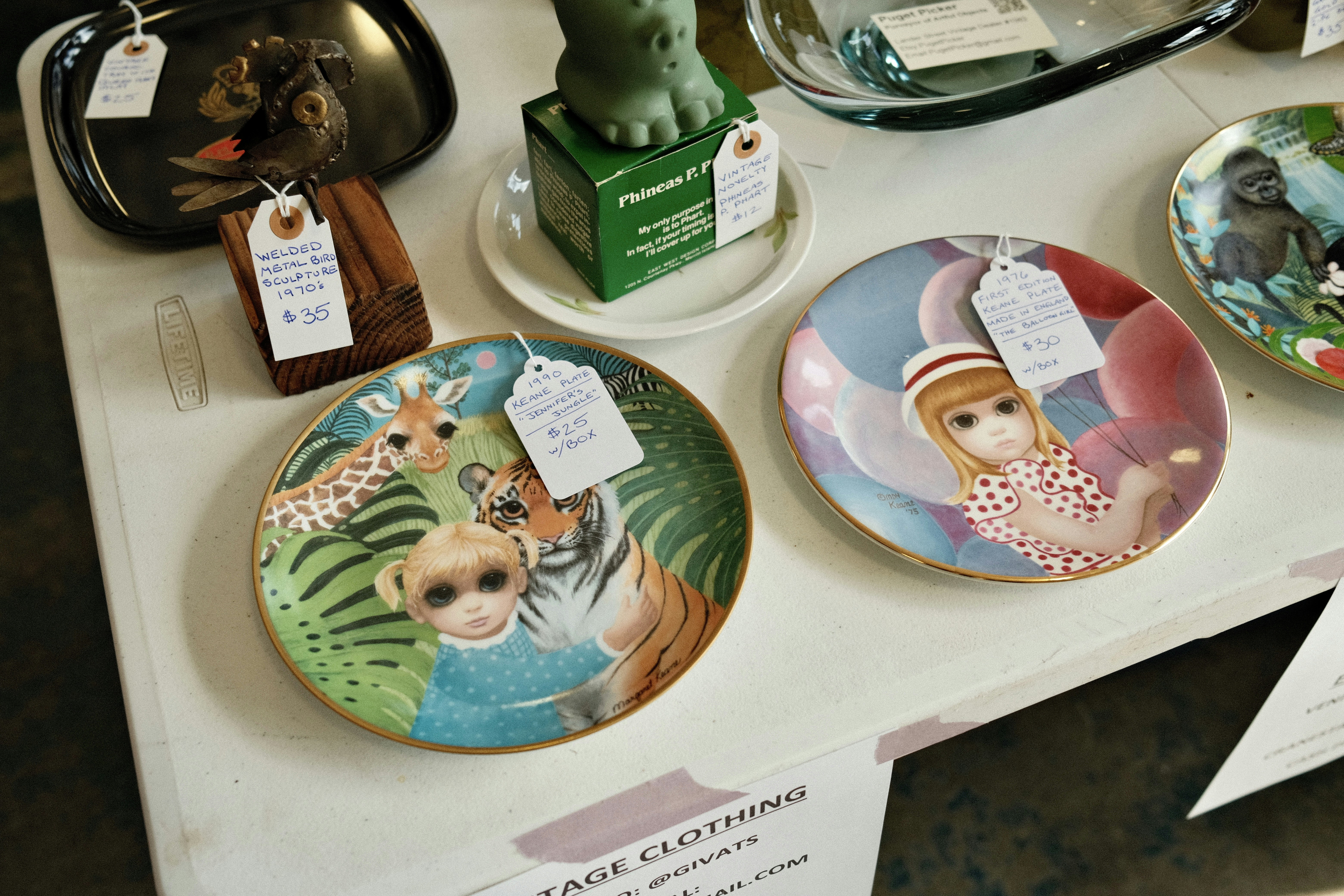 Porcelain Playful Portraits: Doll-Themed Plates on a White Display Table
