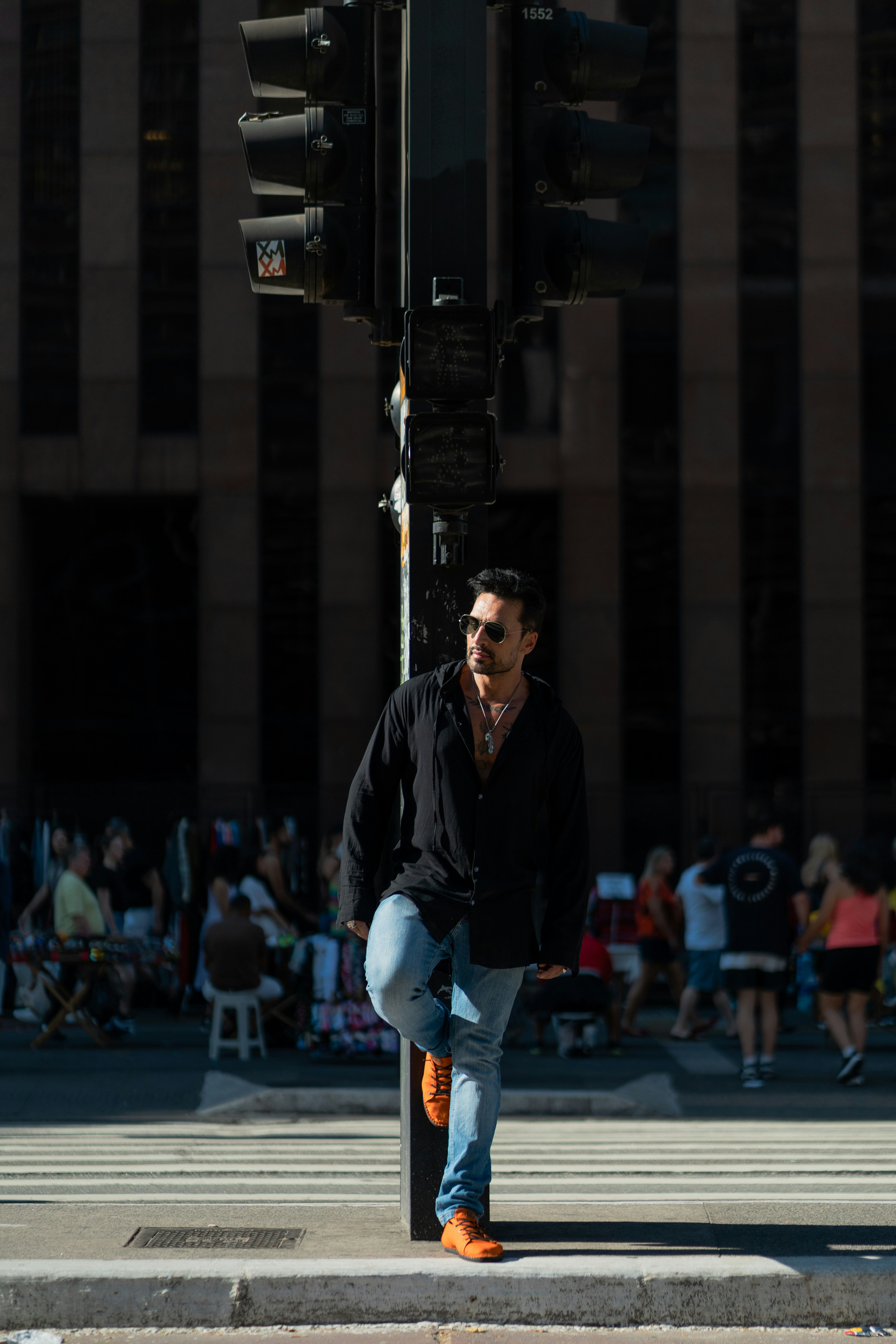 Signalbound: A solitary figure anchors a busy intersection