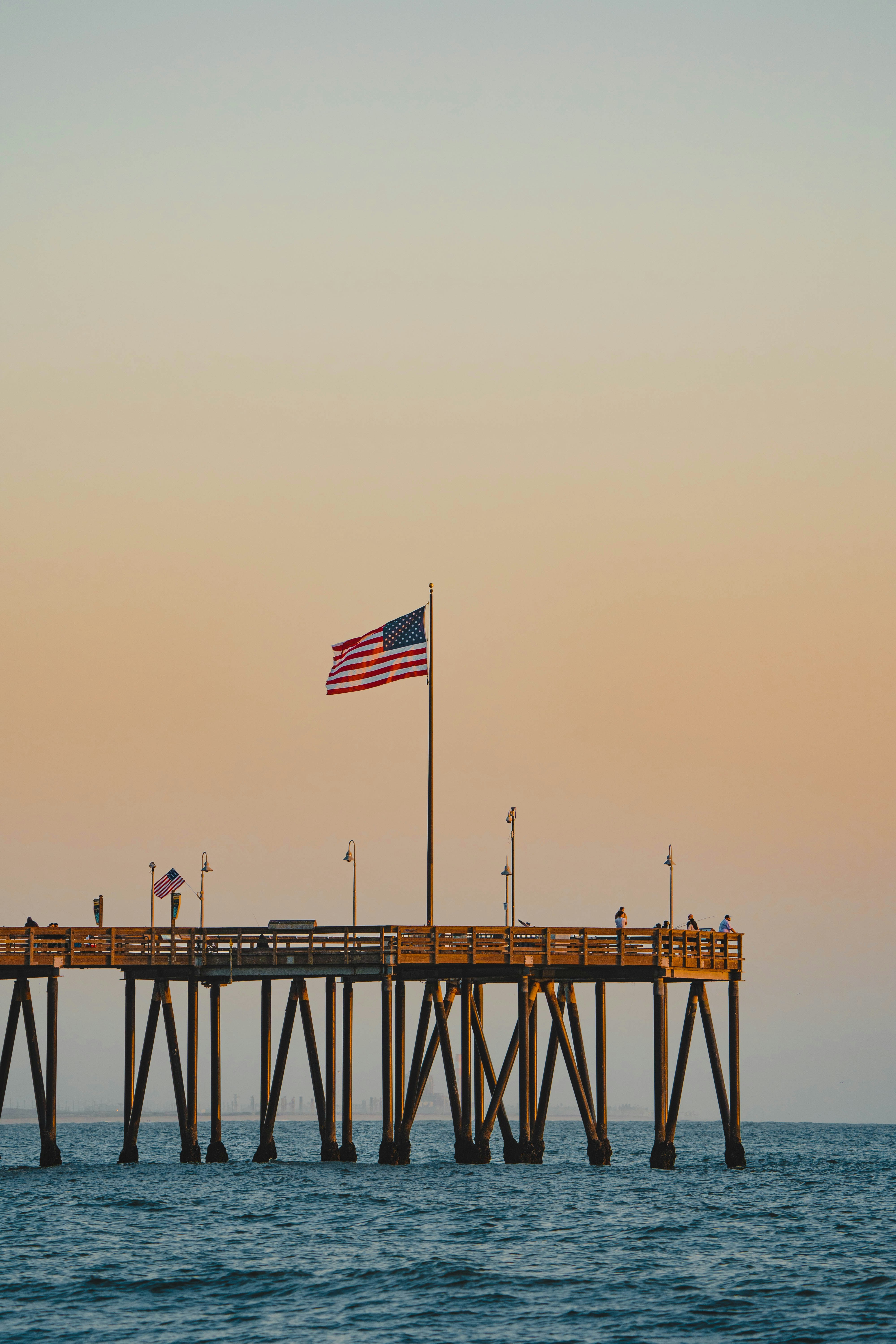 A pier with a flag on top of it photo – Free American flag Image on ...