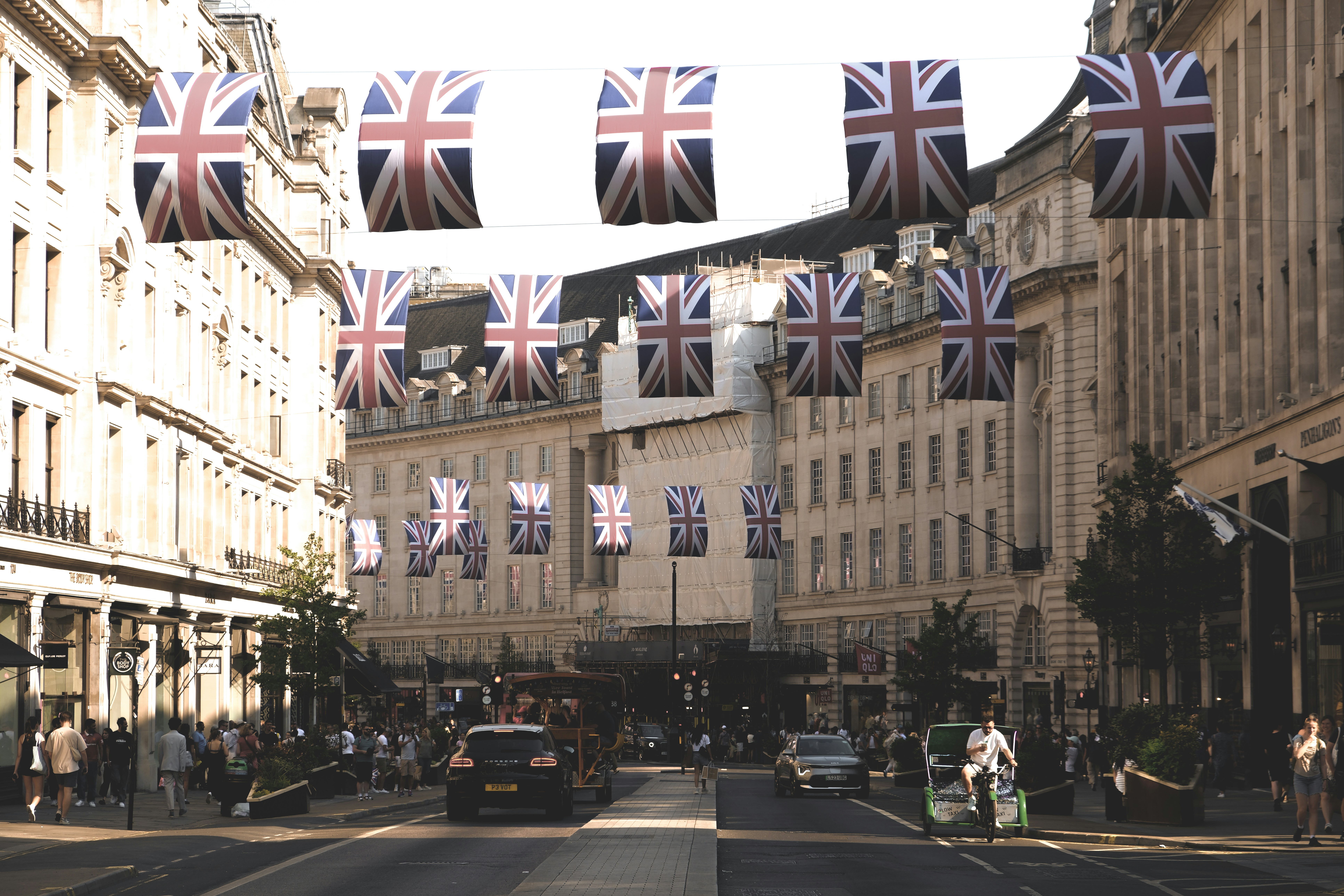 A british flag hanging over a city street photo – Free London Image on ...