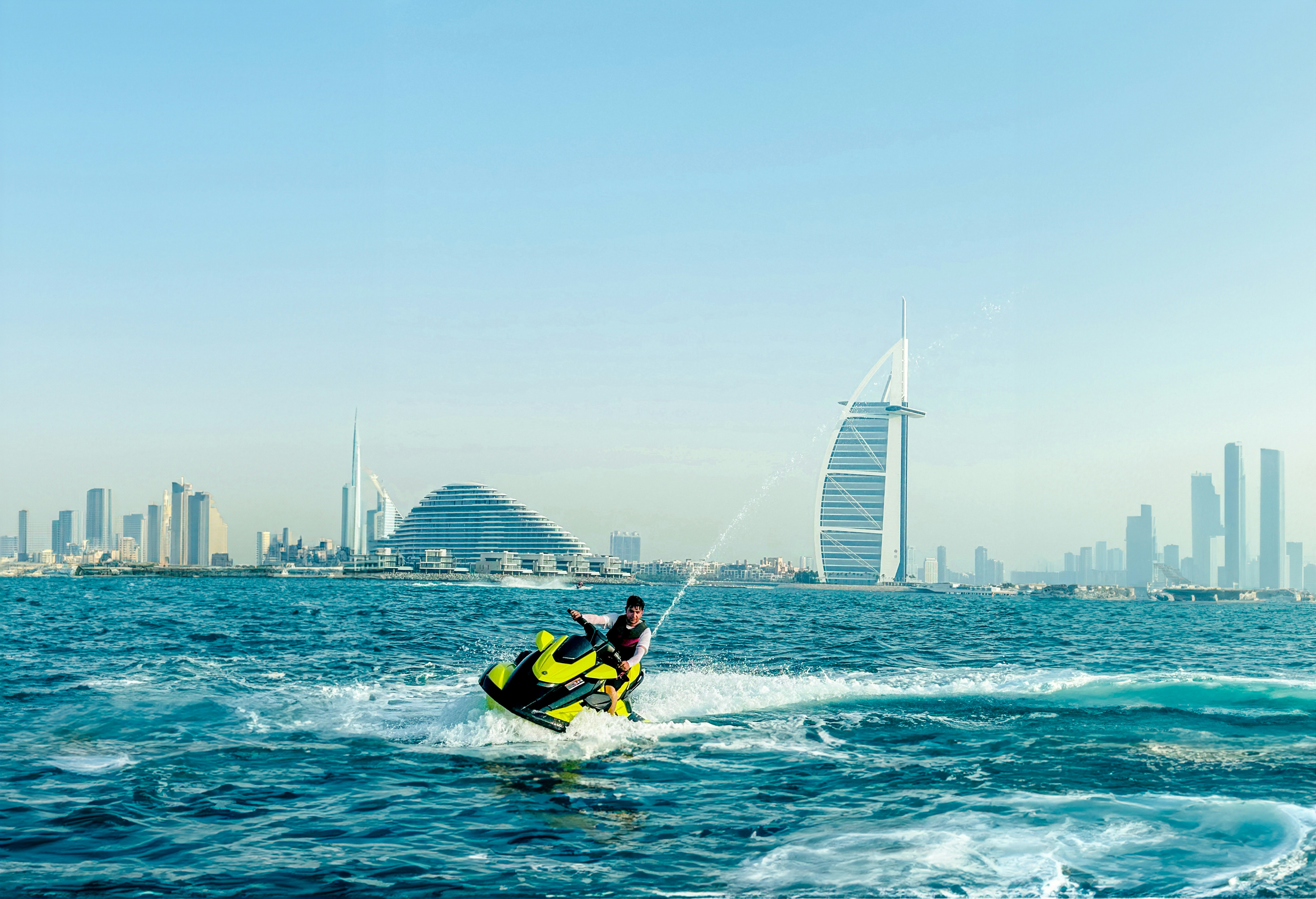 A man riding a jet ski on top of a body of water photo – Free Jet ski ...