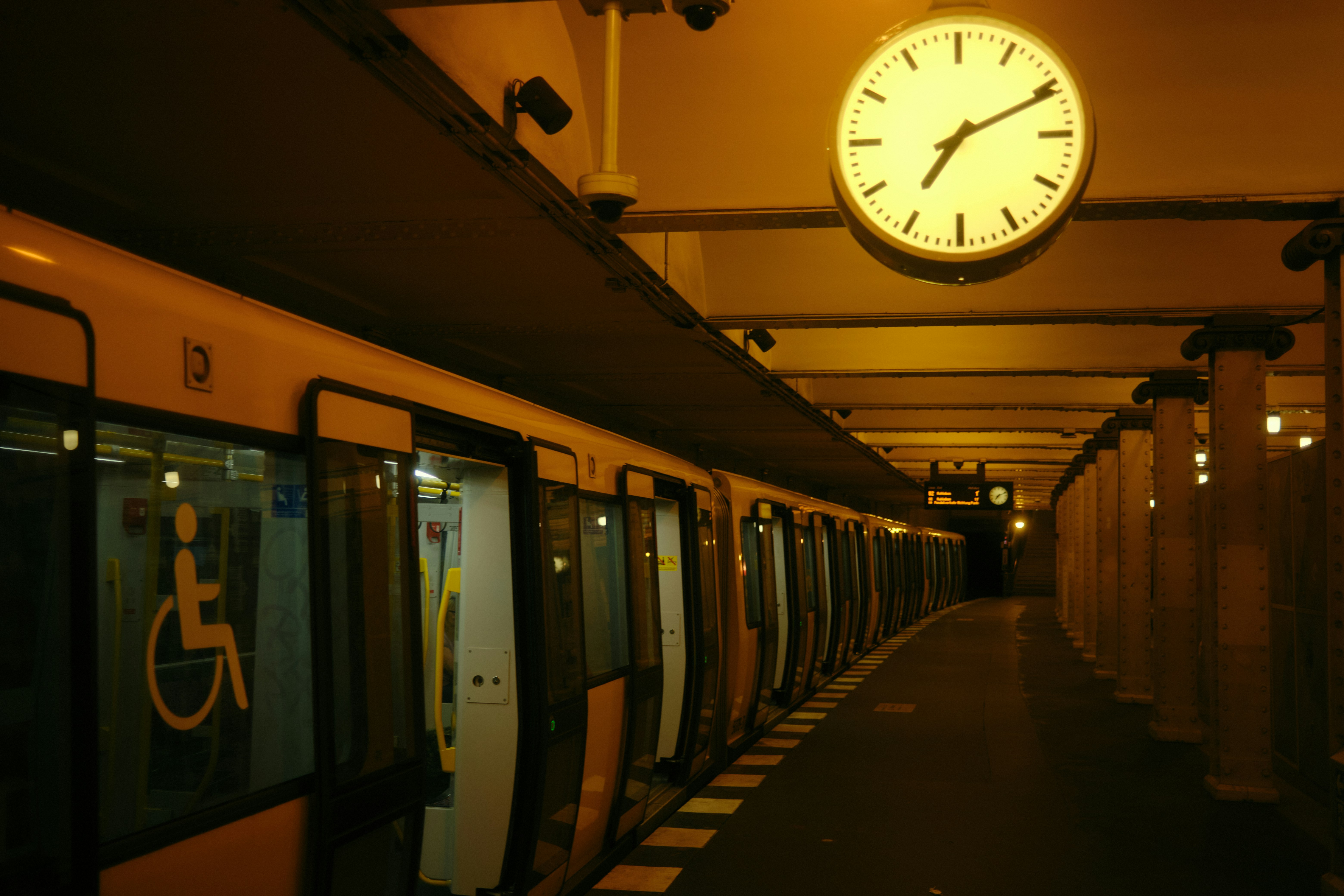 Amber Clock Over Quiet Trains: A Subterranean Platform at Dusk