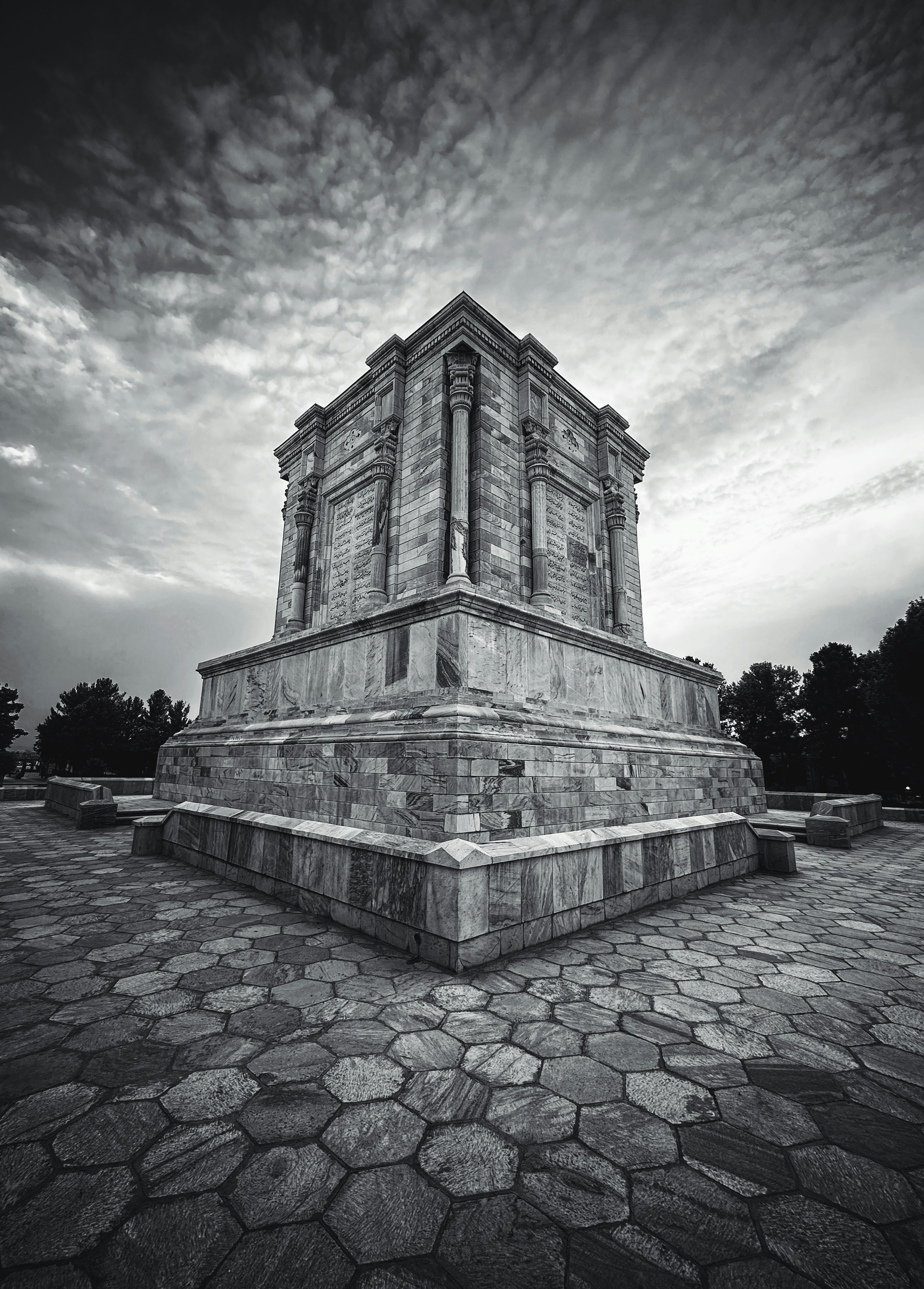 Monumental Stone Chrysalis Rising from a Serene Plaza