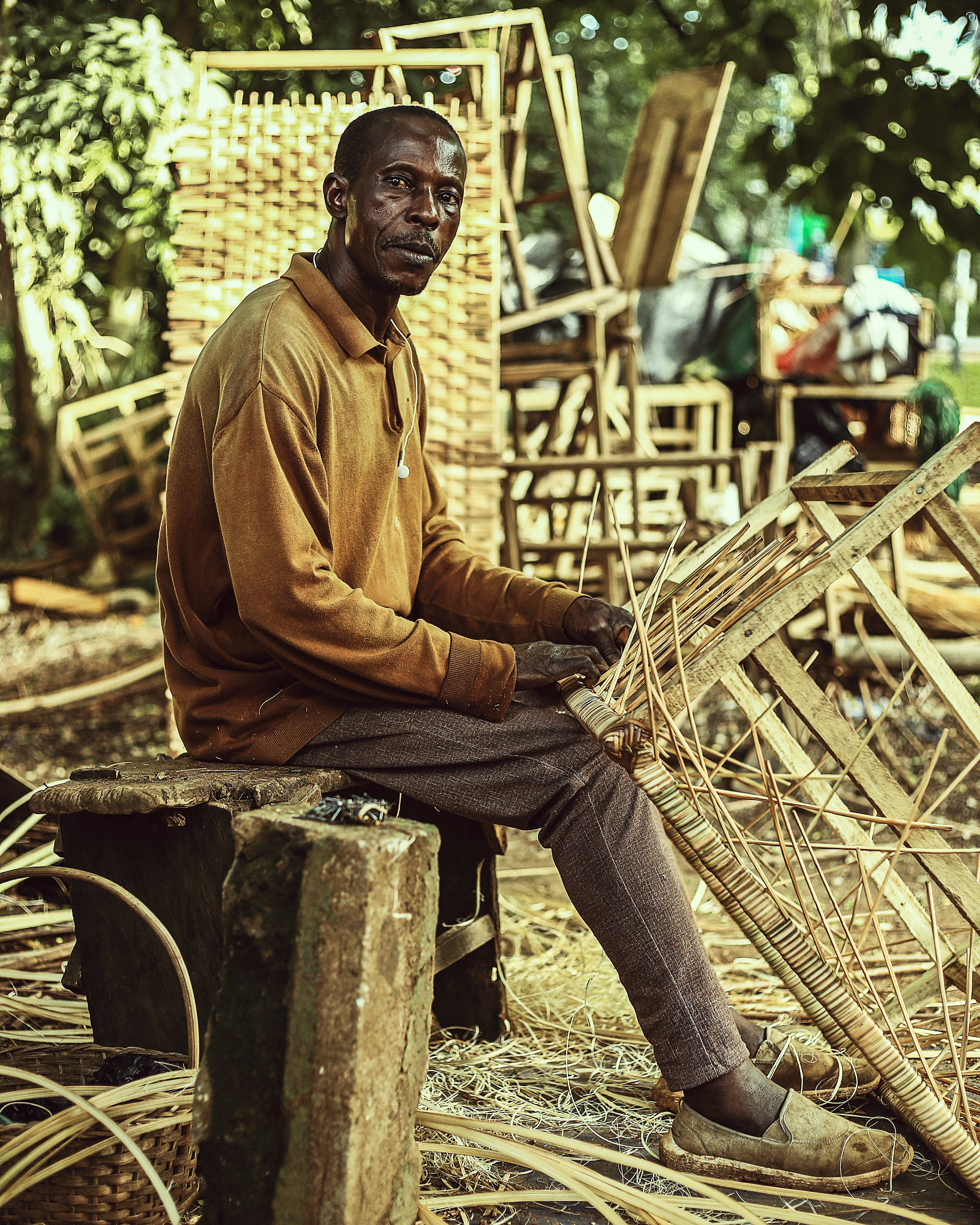 Weaving Focus: A Craftsman in Sunlit Clay and Wood