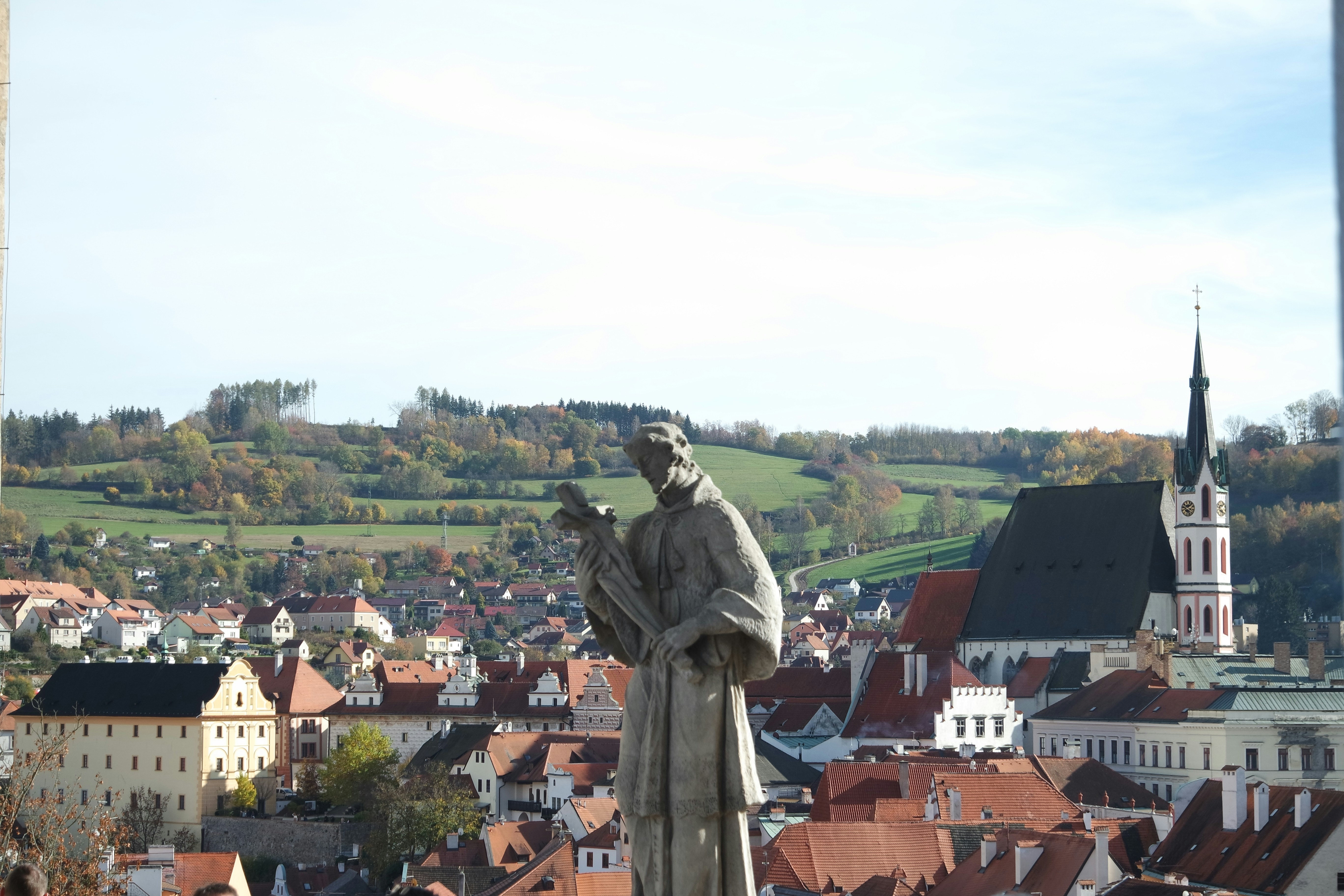 Stone Sentinel Over a Red-Tiled Townscape