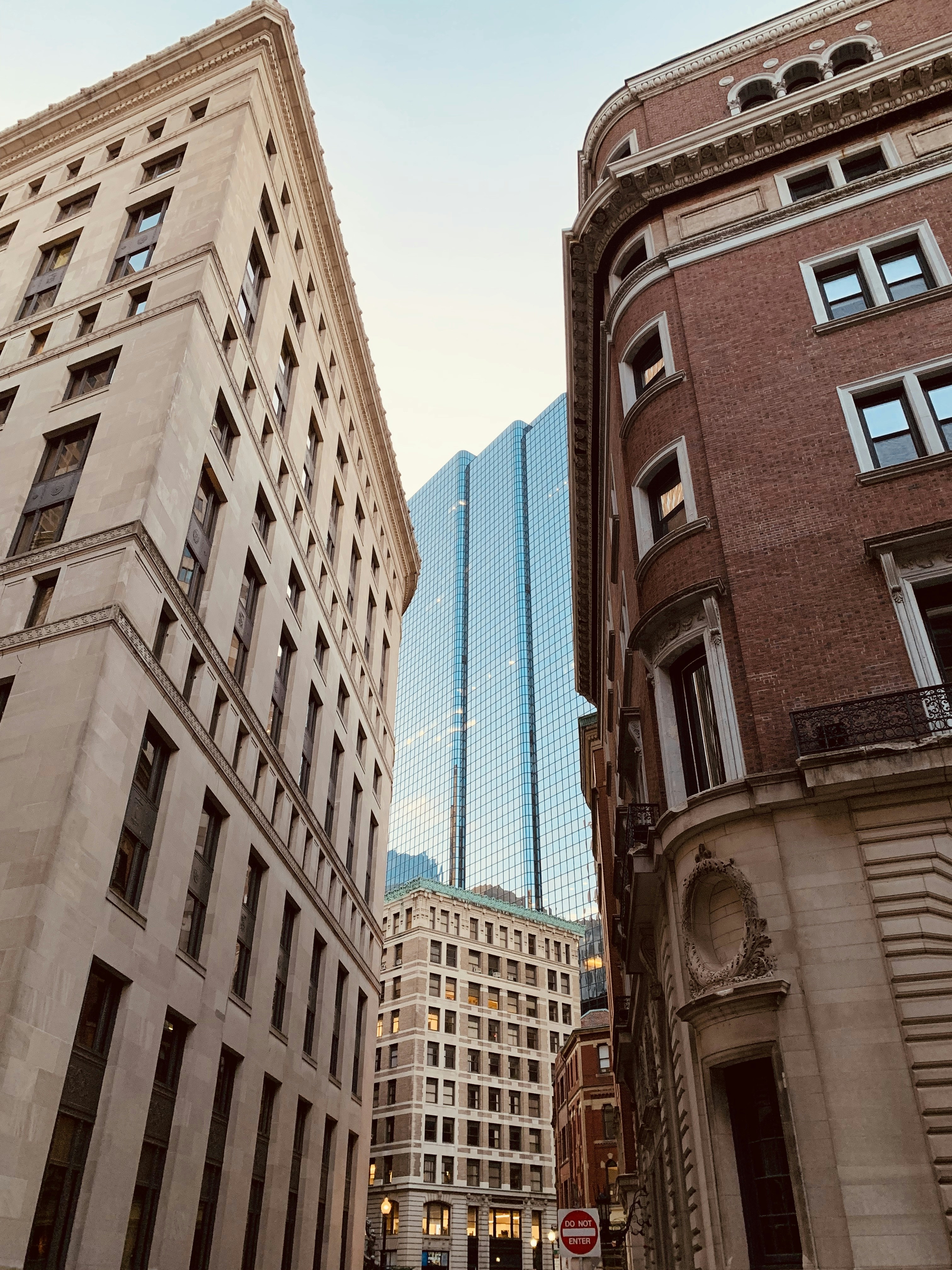 A couple of tall buildings sitting next to each other photo – Free ...