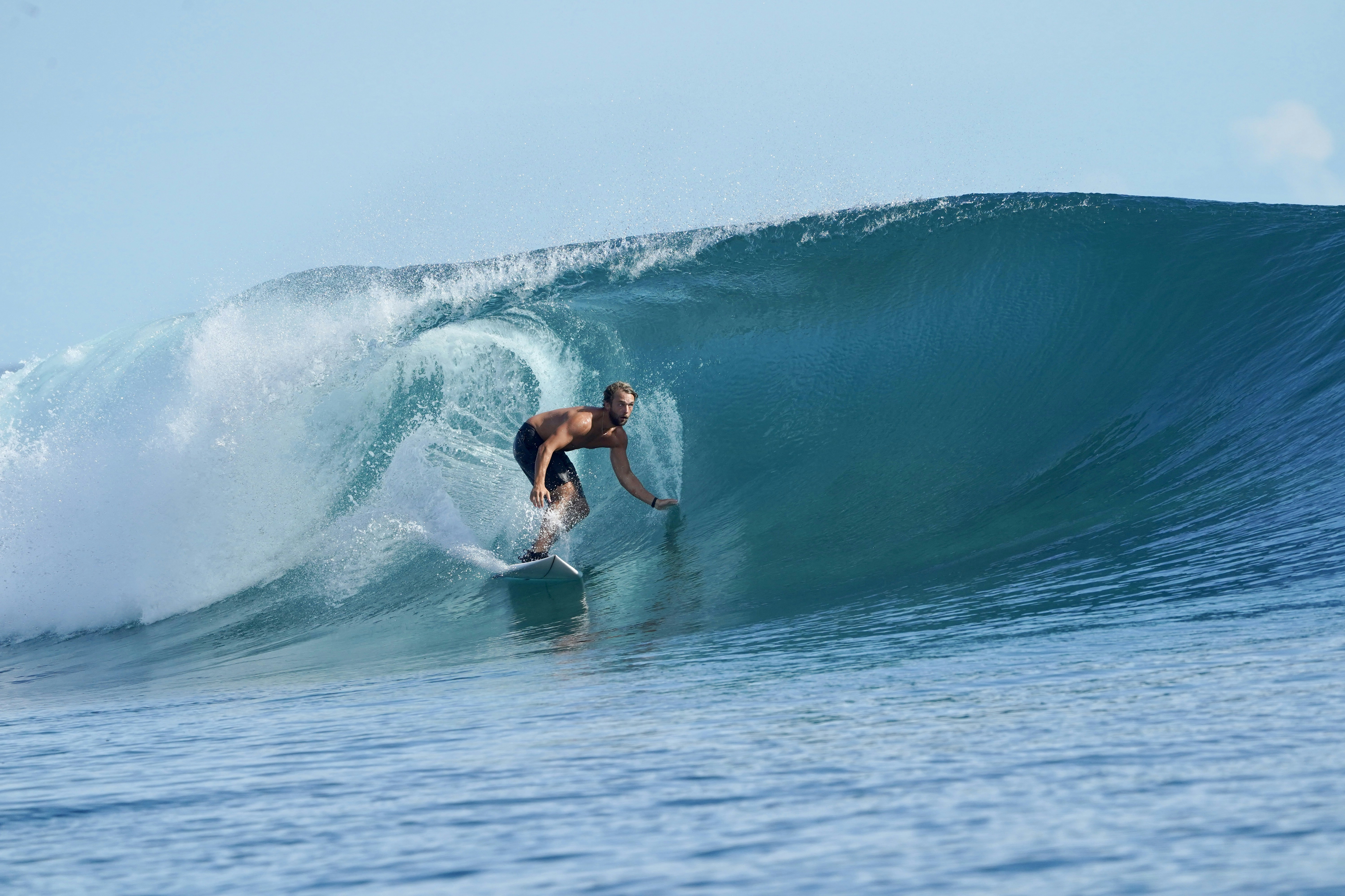 A man riding a wave on top of a surfboard photo – Free Mentawai islands ...