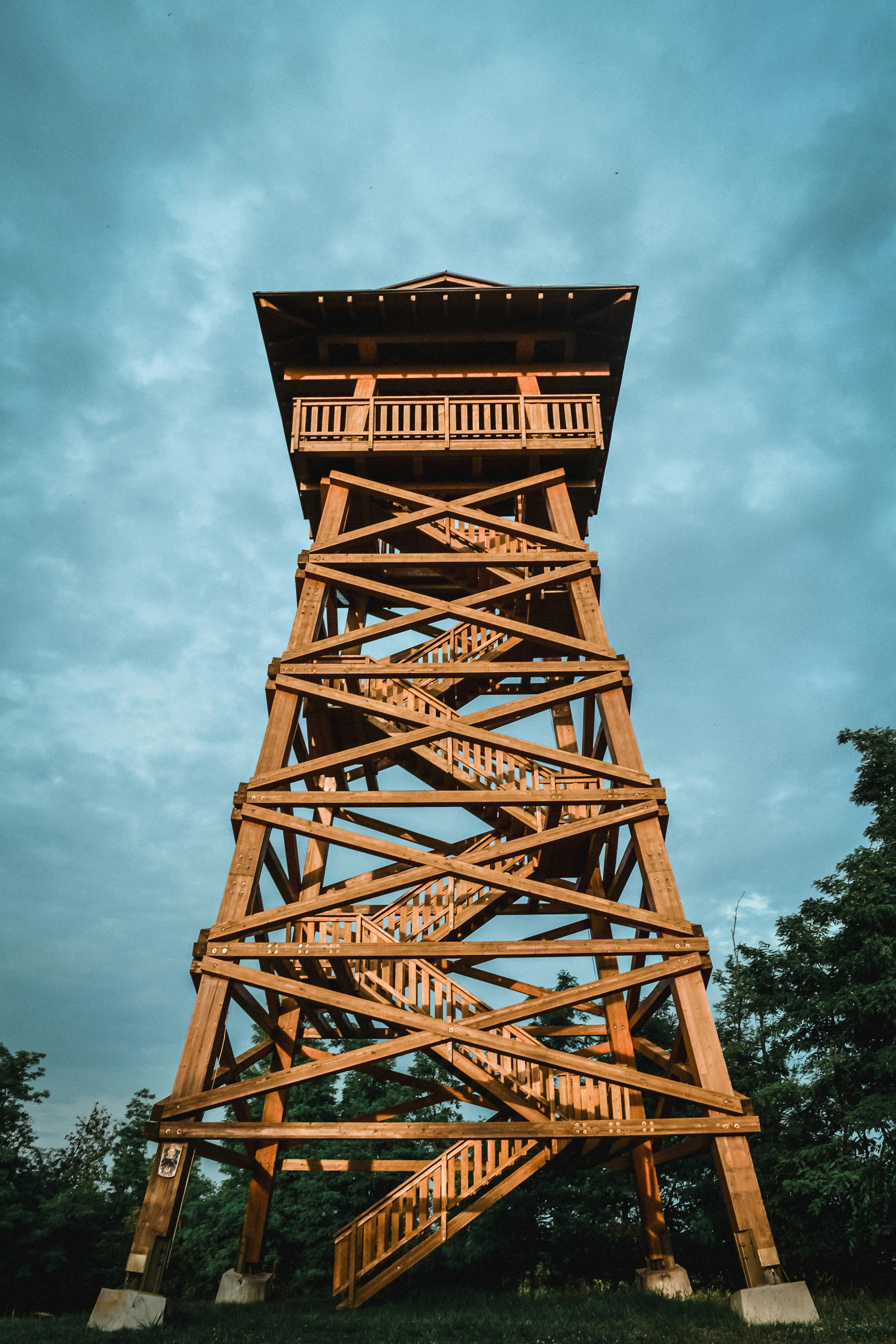 Crisscrossed Timber Watchtower Reaching Toward a Clear Sky
