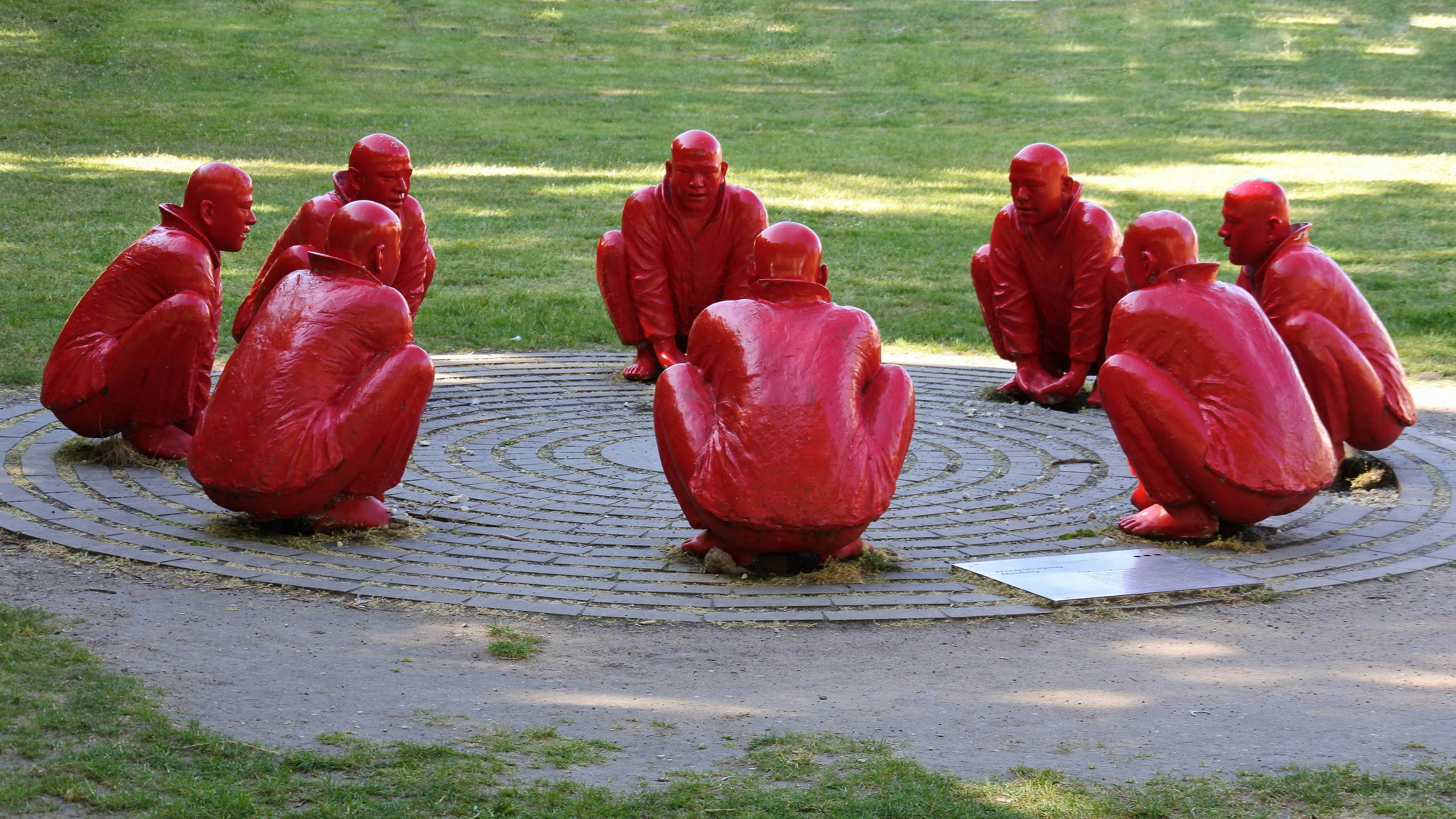 A group of red statues sitting on top of a circle photo – Free Bamberg ...