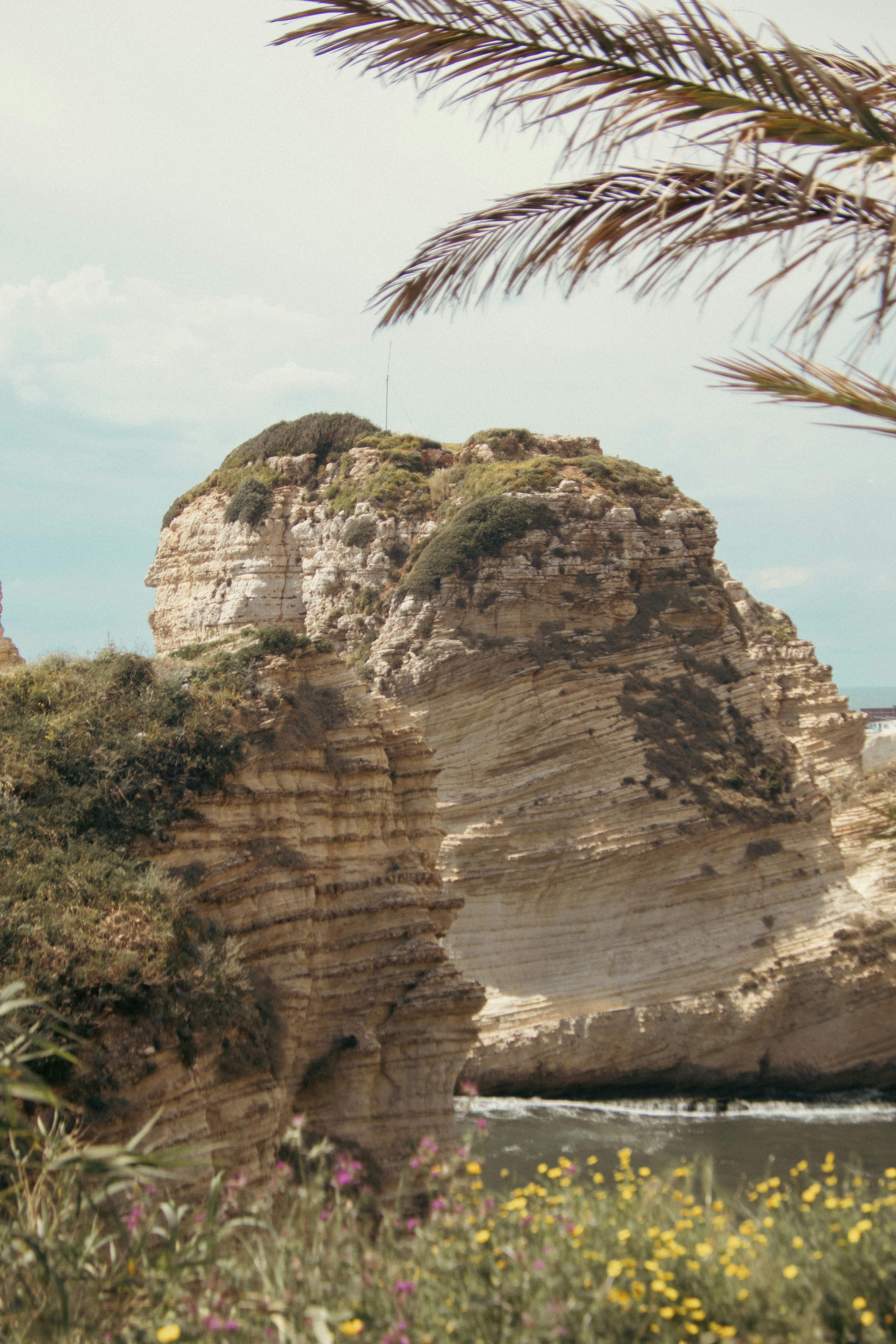 a large rock outcropping next to a body of water