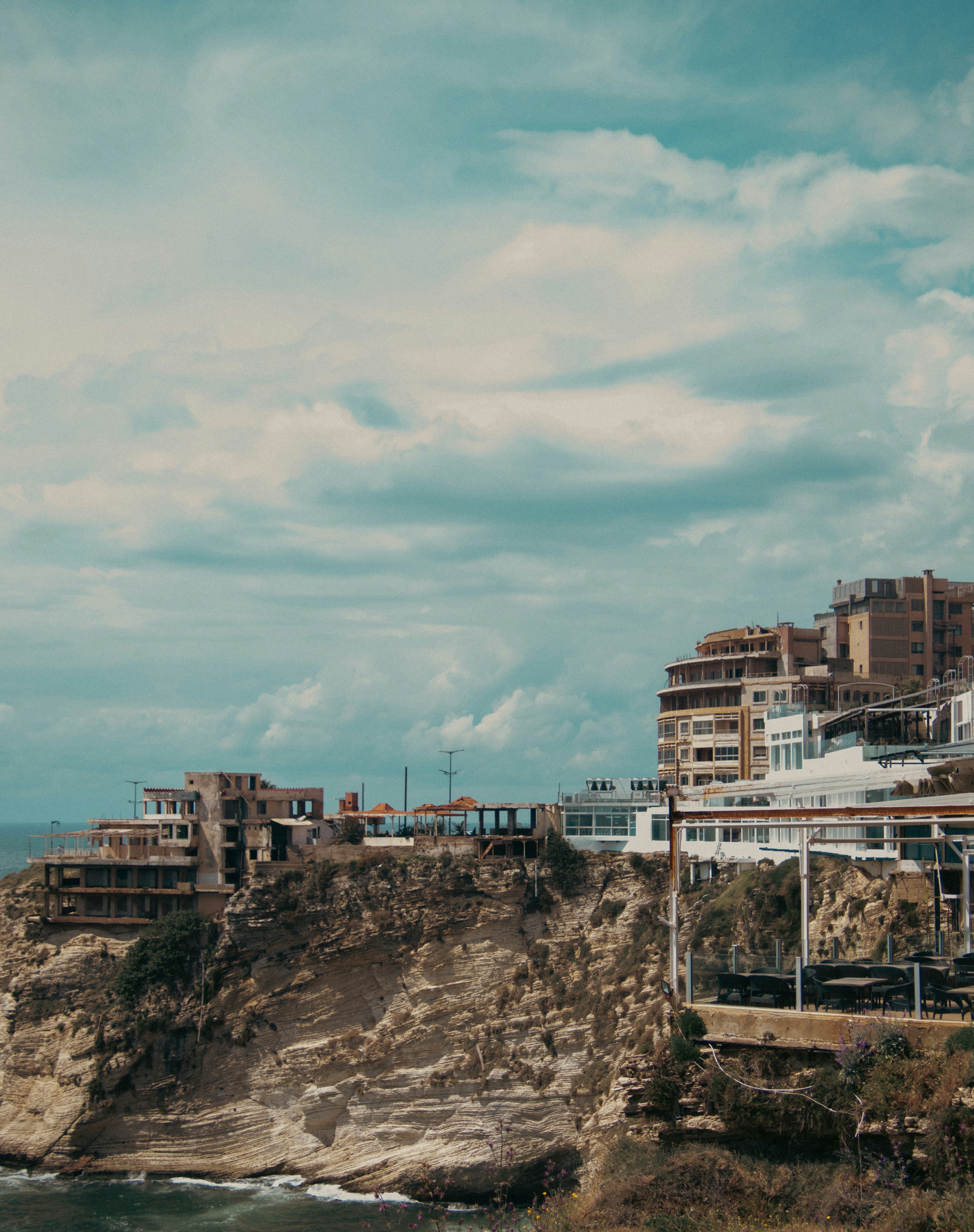 A view of a city on a cliff overlooking the ocean photo – Free Lebanon ...
