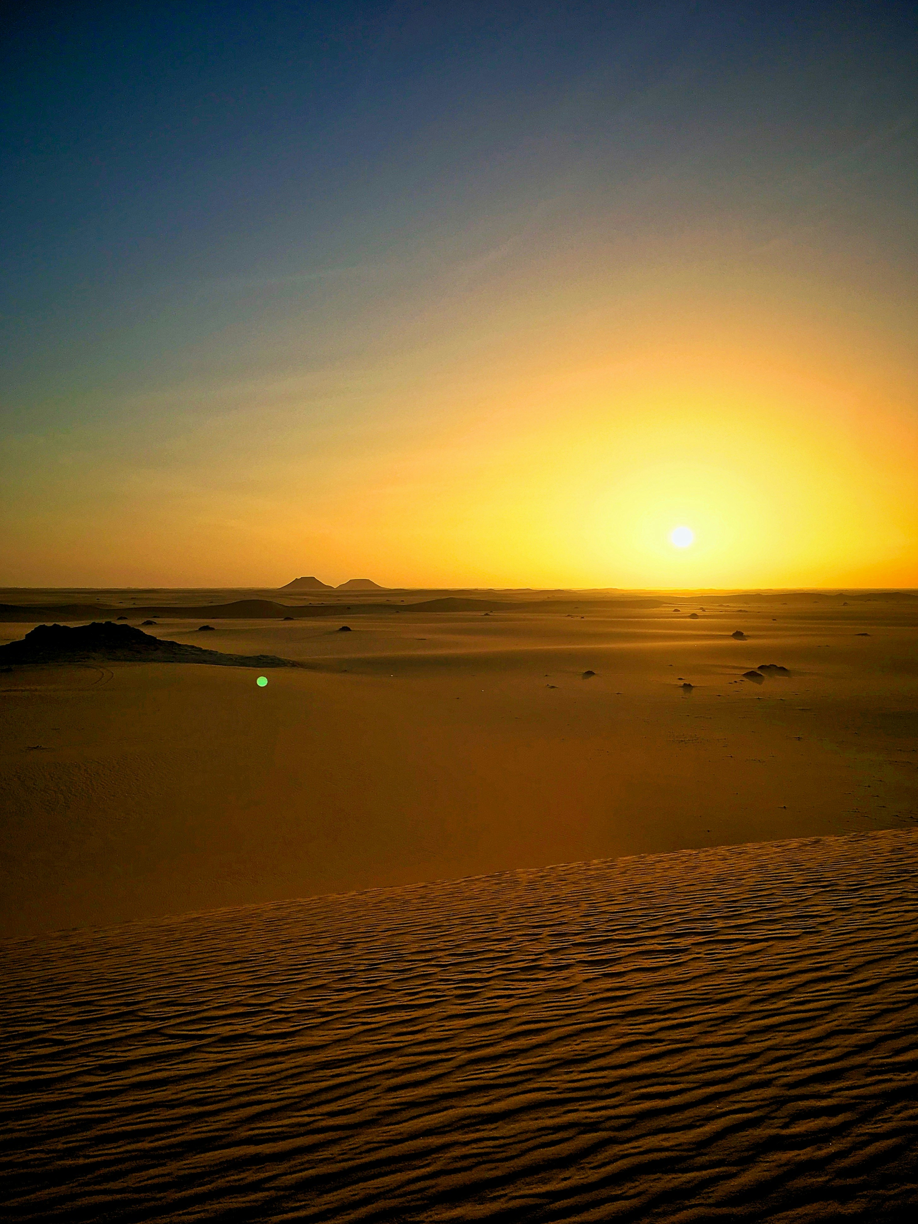The sun is setting over a sandy area photo – Free Libya Image on Unsplash
